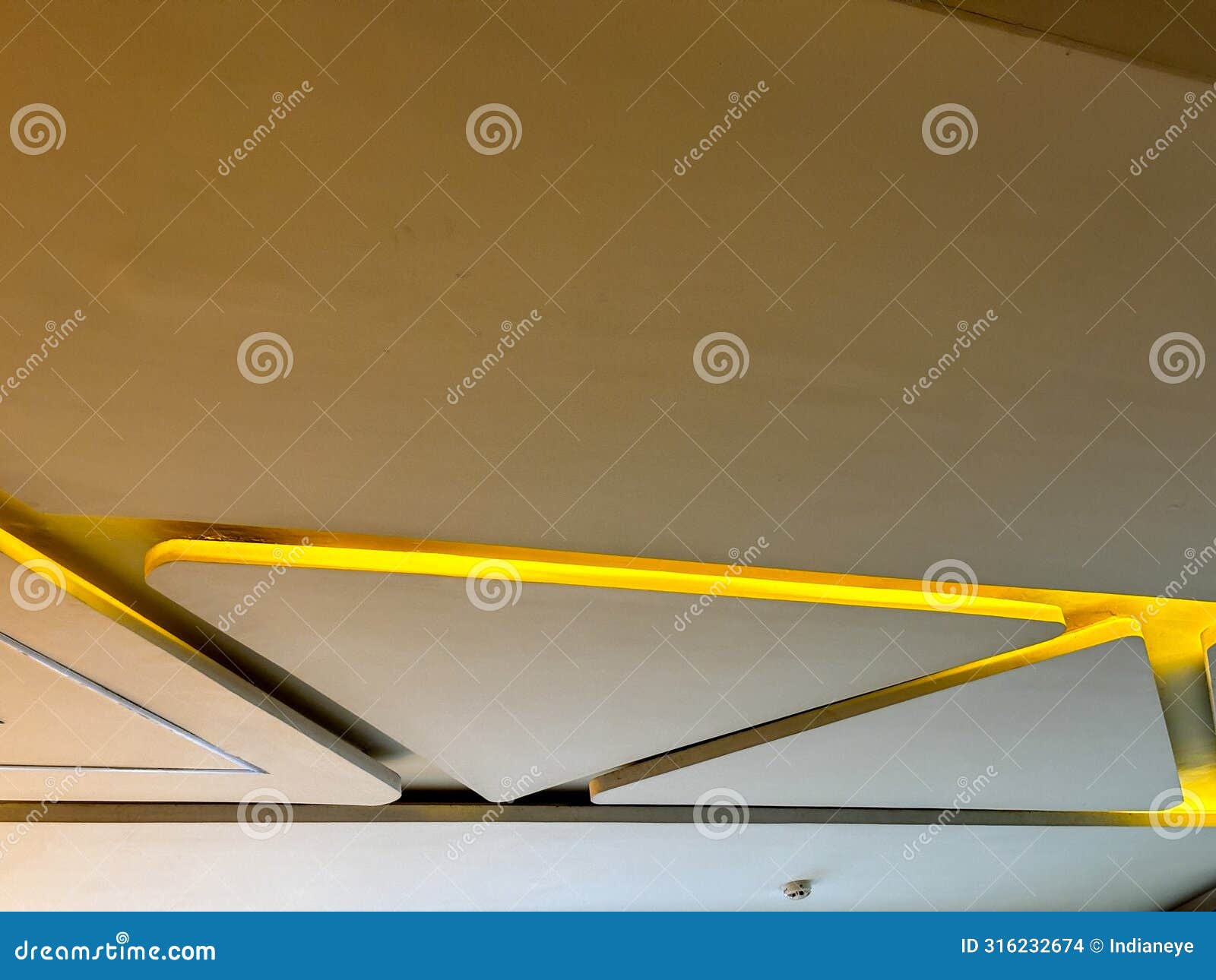 A Ceiling with a Yellow Light Shining on it Stock Photo - Image of ...