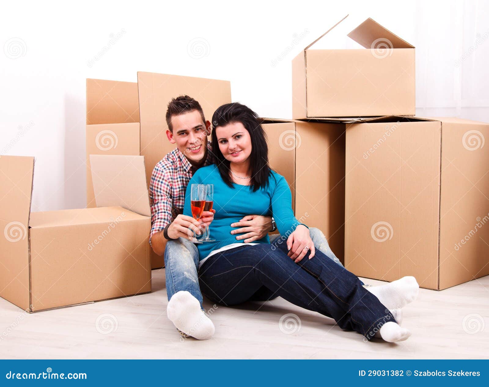 Celebrating Moving Together Stock Photo - Image of looking, sitting ...