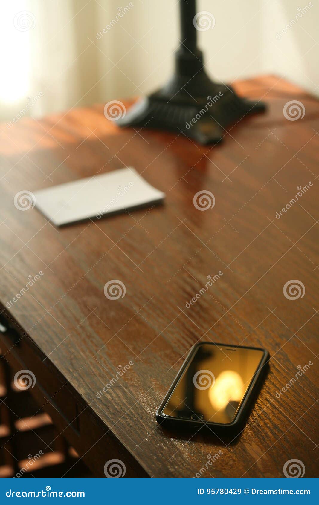 Cell phone on a desk stock image. Image of light, desk - 95780429