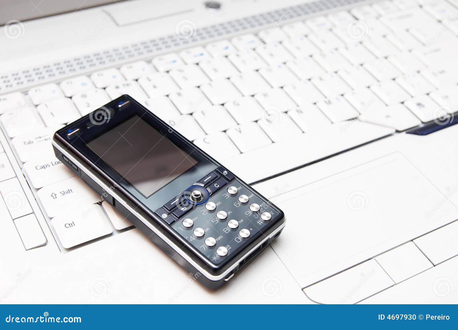 Cell phone on a laptop stock photo. Image of cellular - 4697930