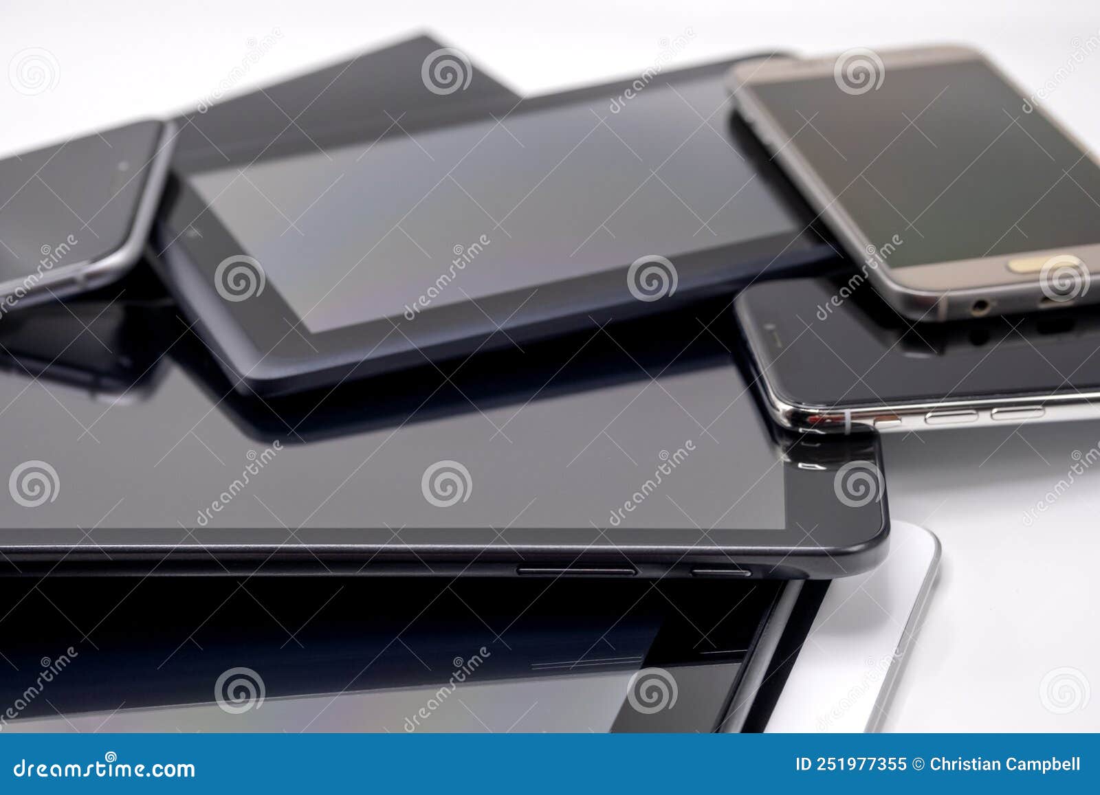 Cell Phones and Pads Piled on Tabletop Stock Image - Image of smart ...