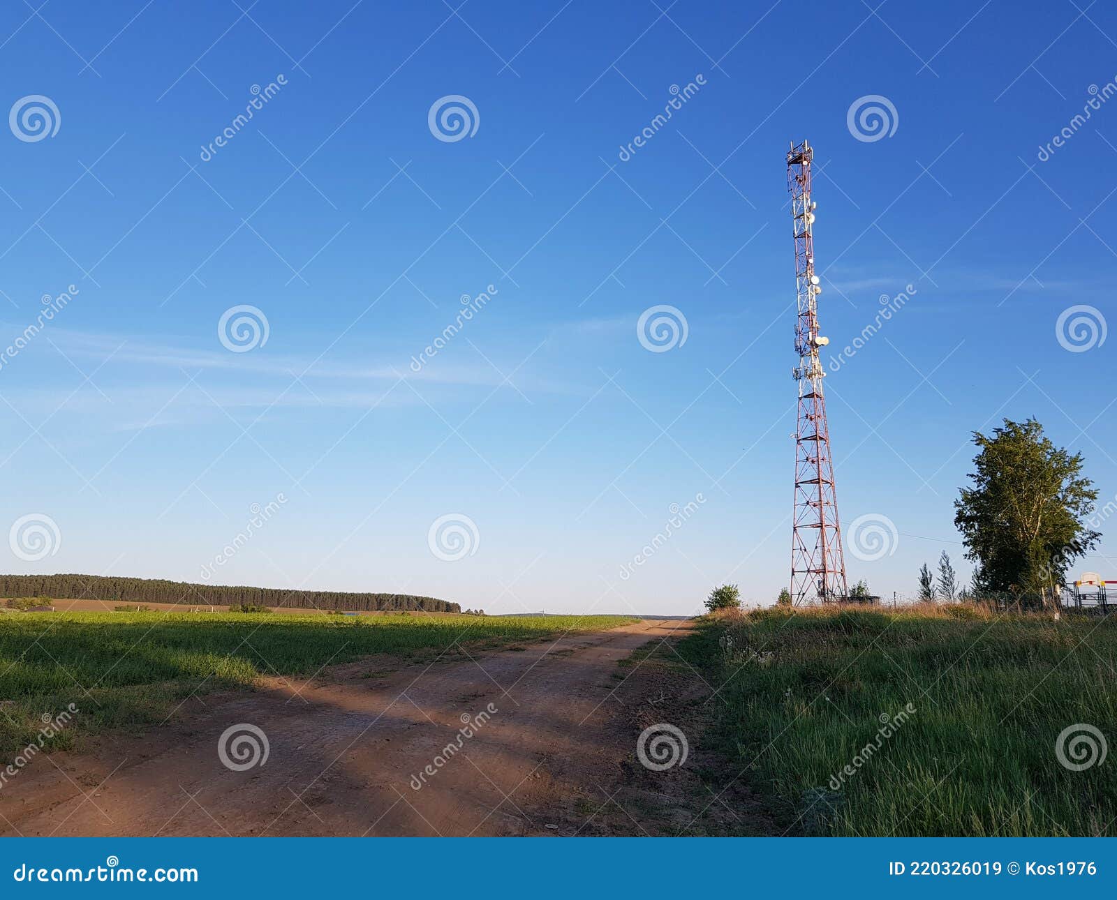Cell tower in the field stock image. Image of green - 220326019
