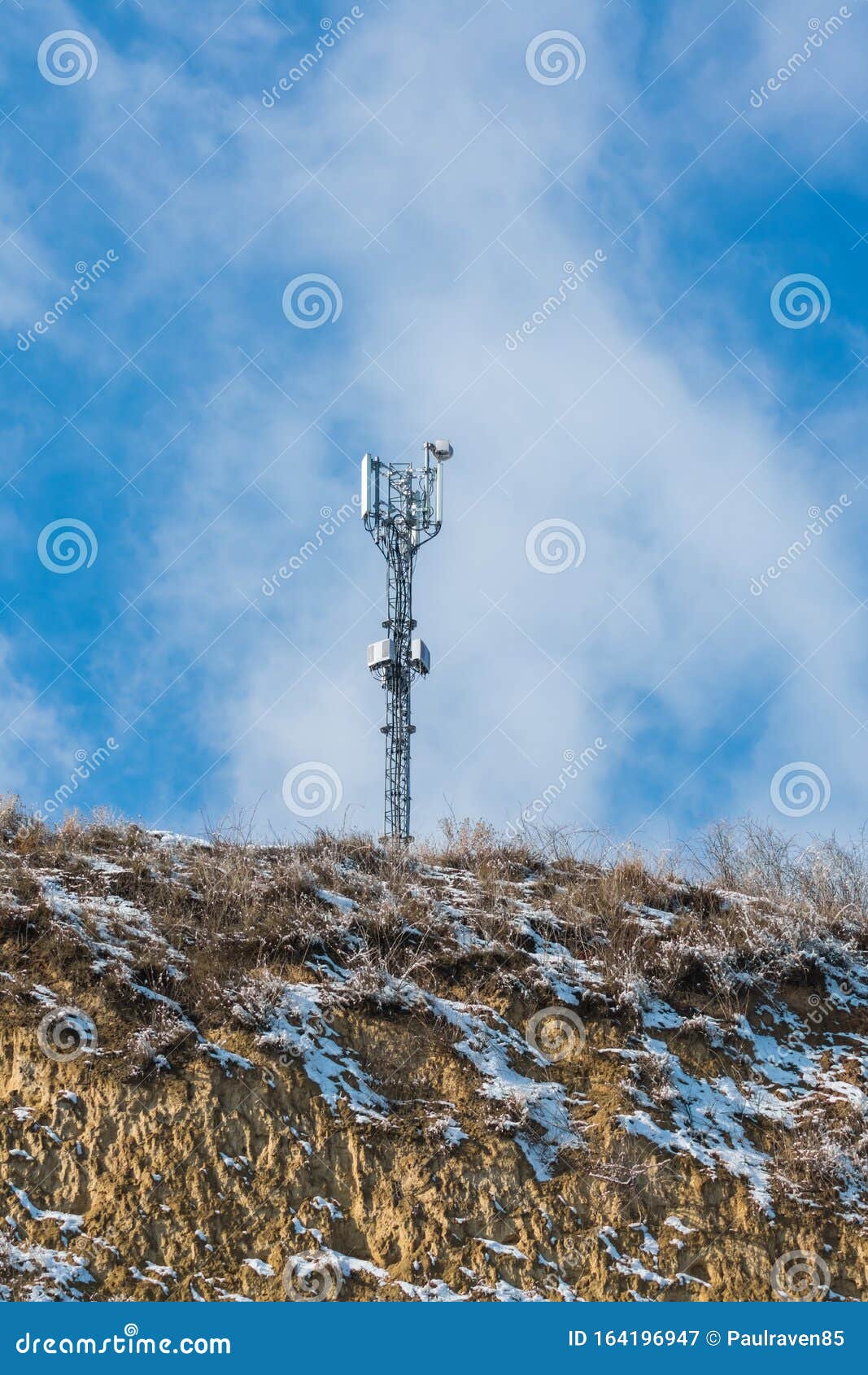 A Cell Tower on a Hill Against a Blue Sky with Light Clouds Stock Image ...