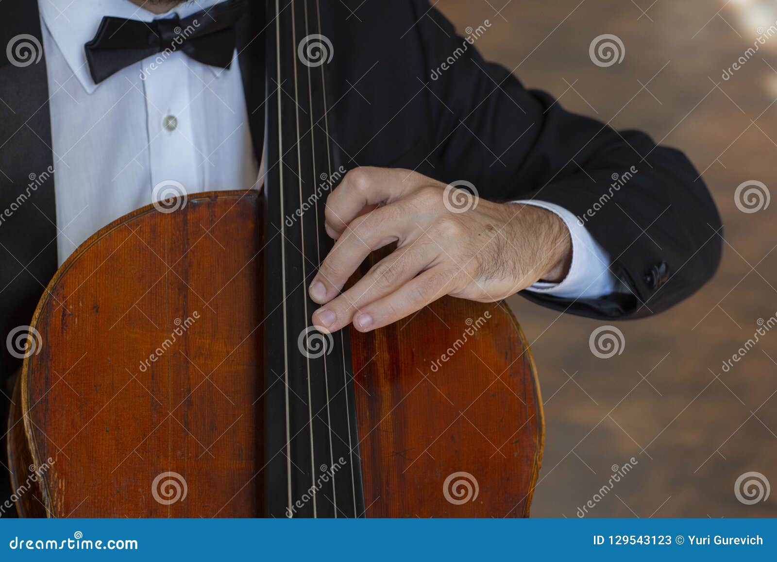 Cello Close-up with a Child`s Hand that Holds the Bow. Stock Image ...