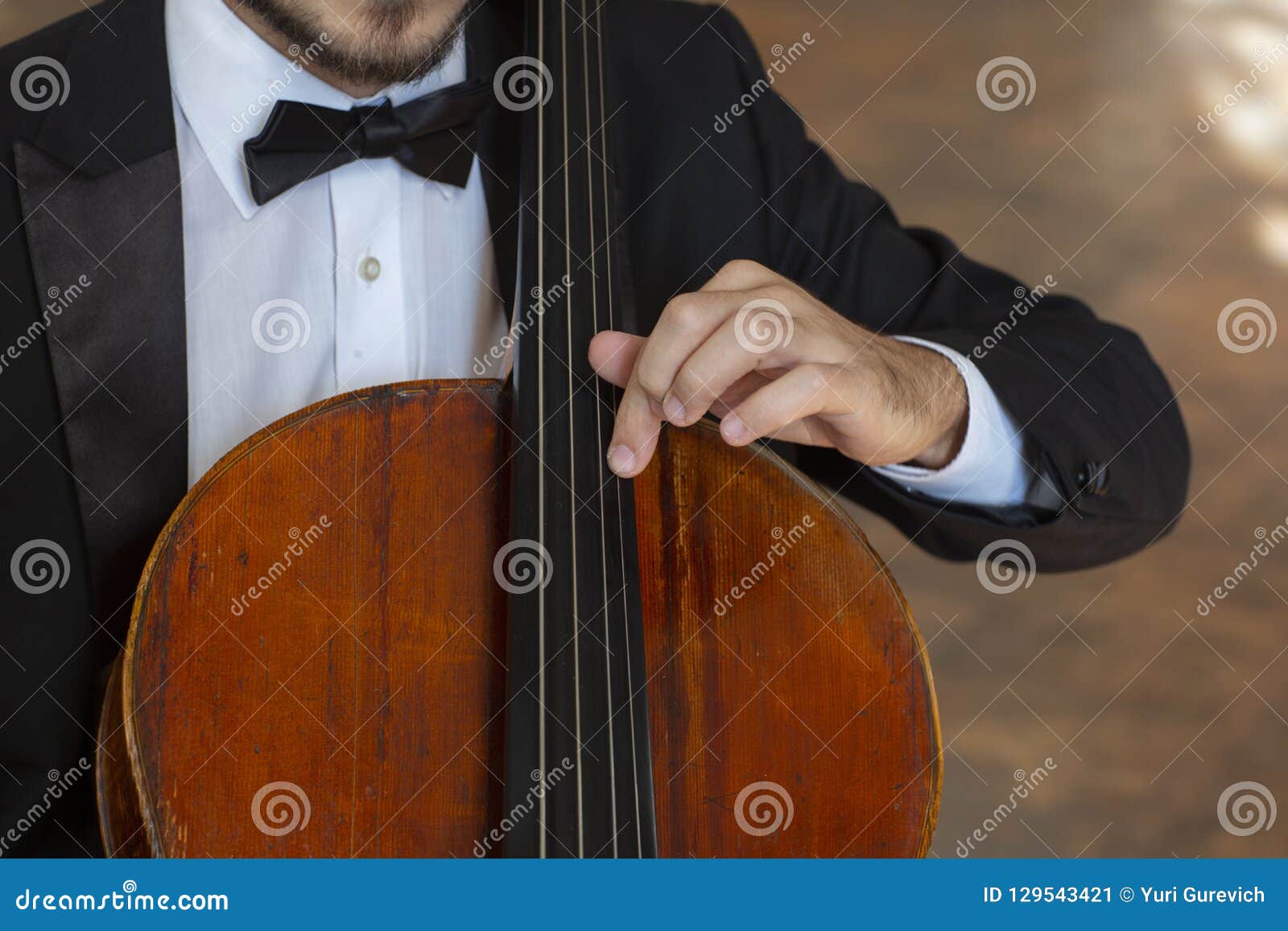 Cello Close-up with a Child`s Hand that Holds the Bow. Stock Image ...