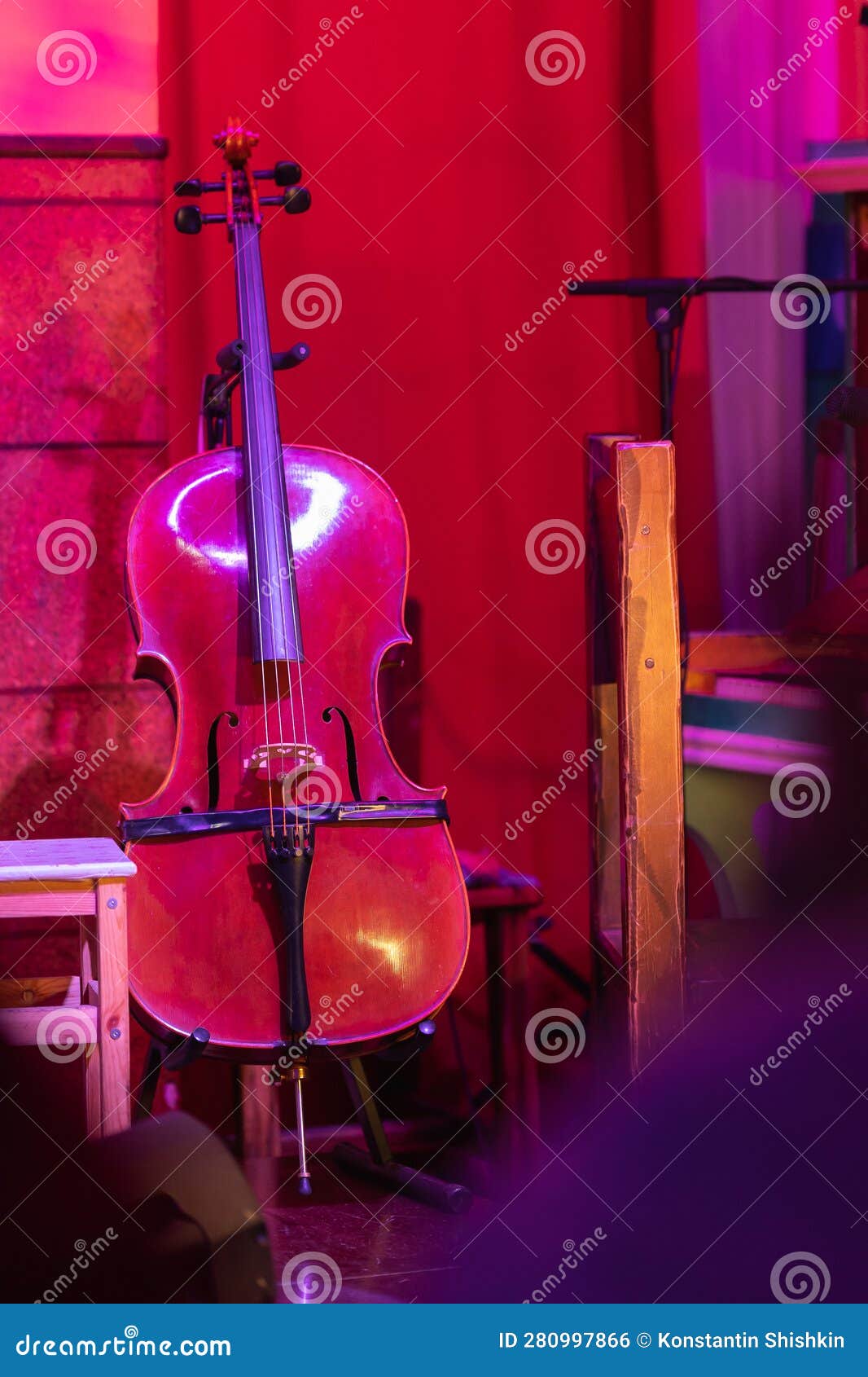 A Cello Stands on an Illuminated Stage in a Local Bar Stock Photo ...