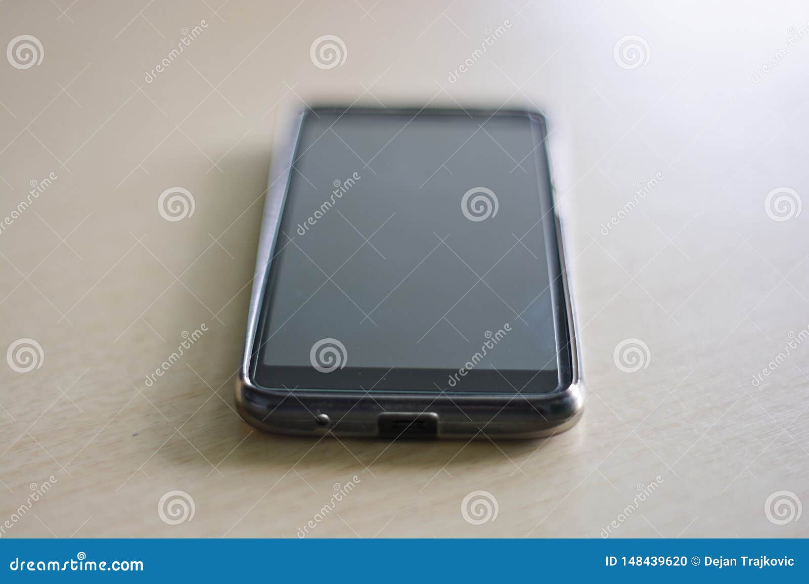 Cellphone on the desk stock photo. Image of display - 148439620
