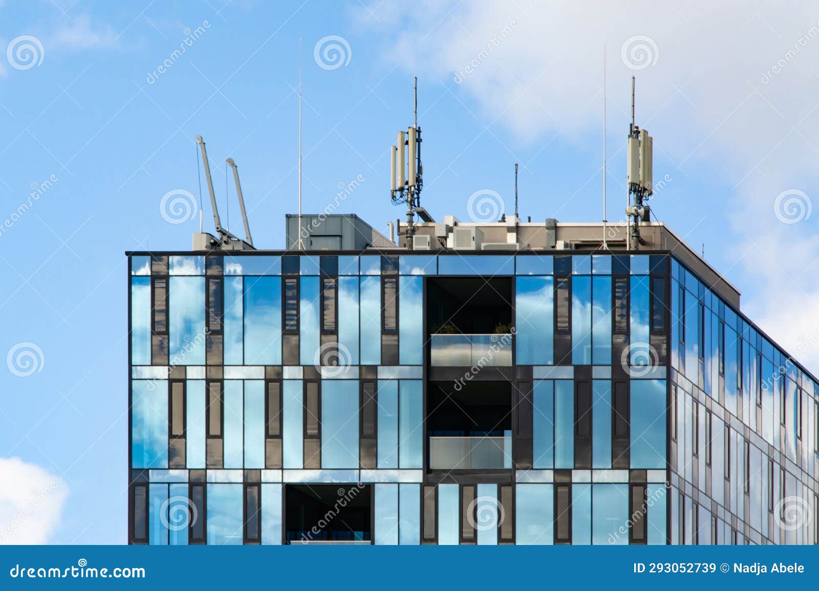 Cellular Antennas on Modern Building Roof. Surface Reflects Clouds ...