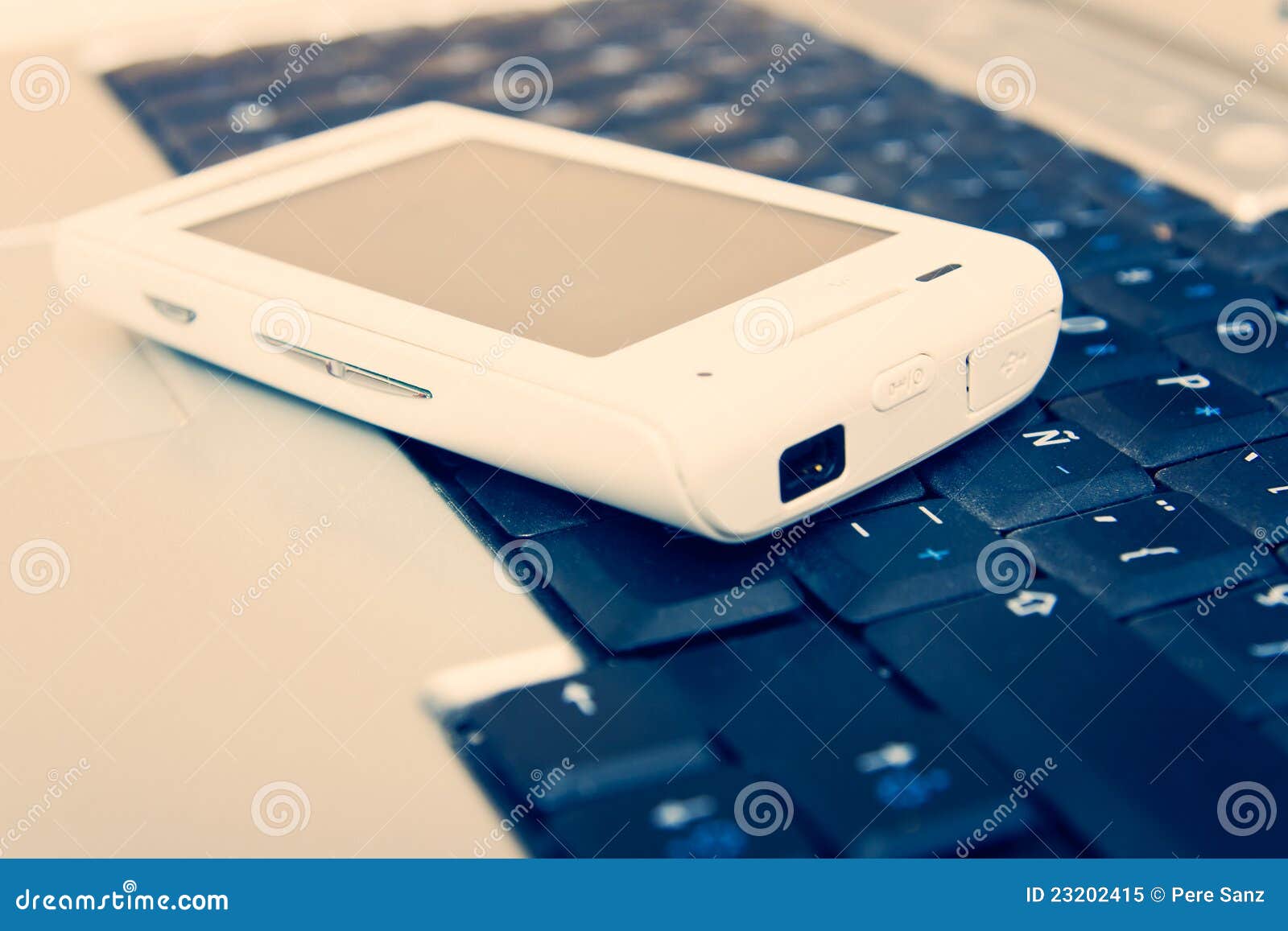 Cellular Phone on Laptop stock image. Image of notebook - 23202415