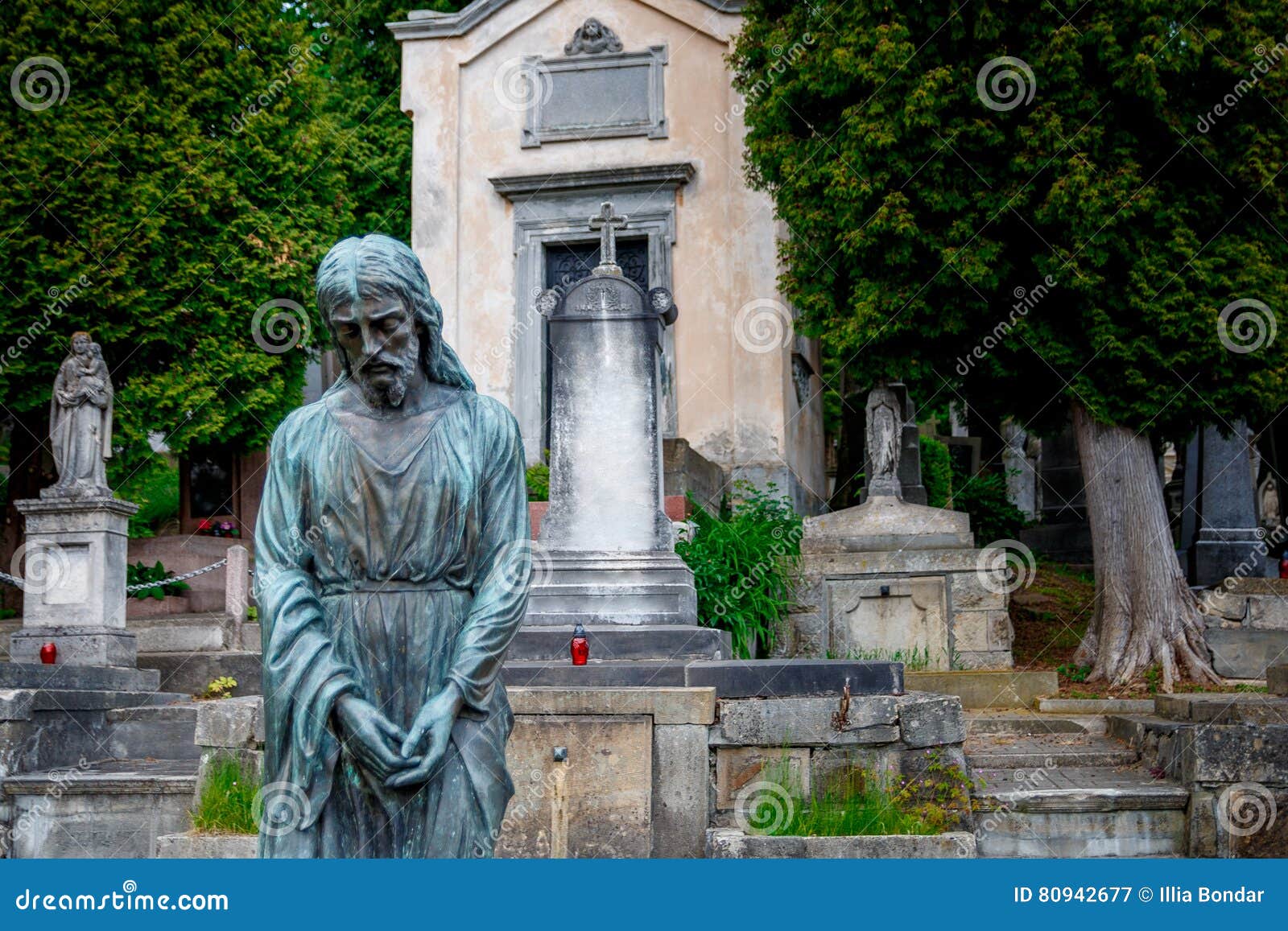 Cemetery with a Sad Man Statue on the Foreground. Stock Image - Image ...