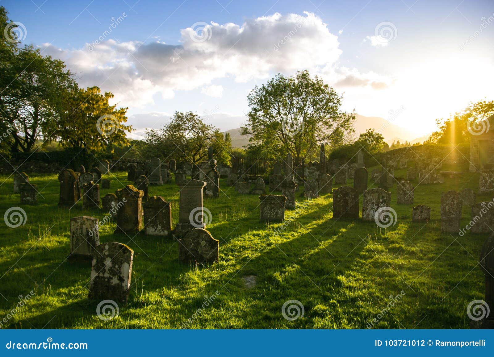 Cemetery at Sunset with Warm Rays of Light Streaming through the Stock ...