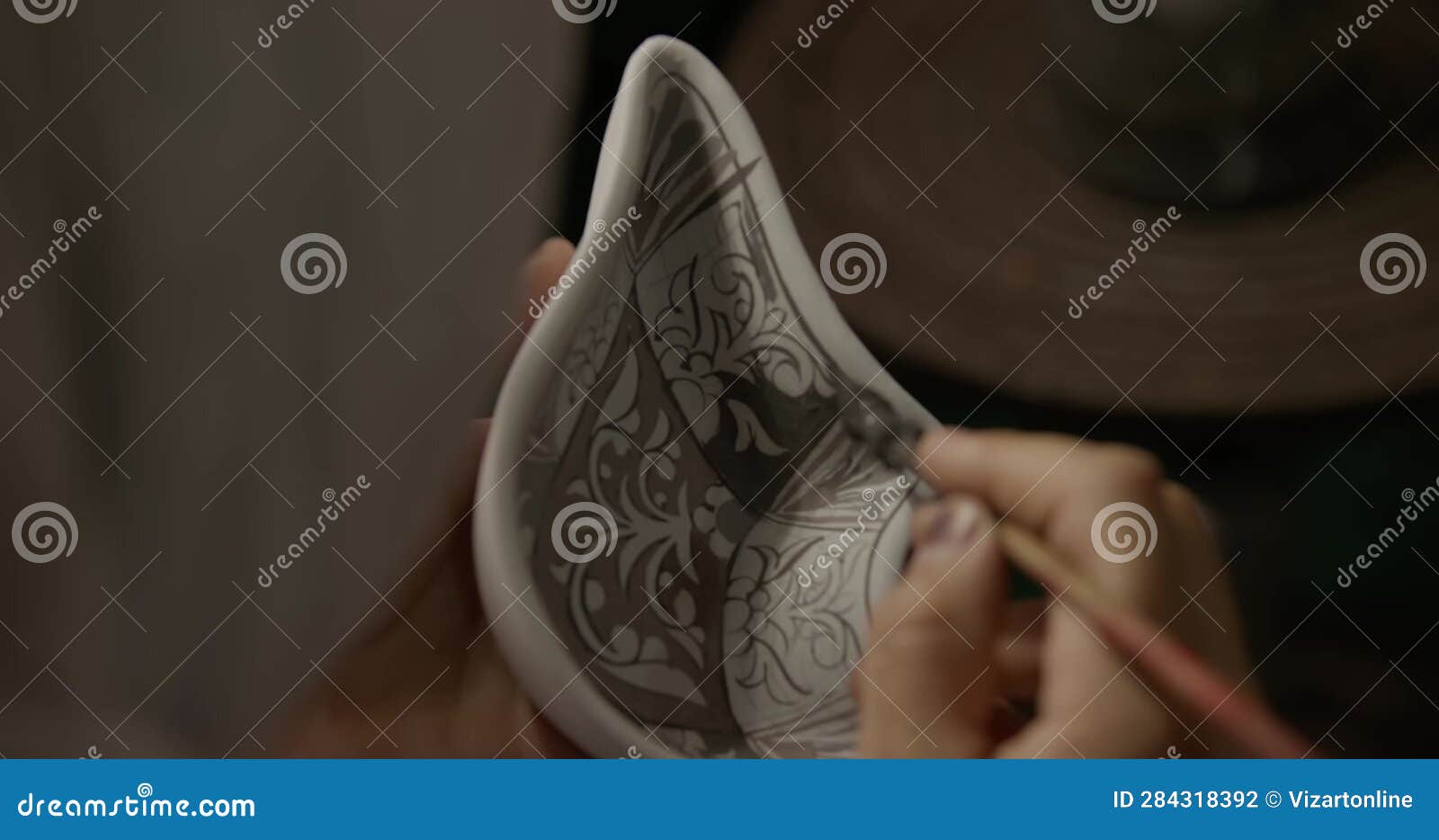 A Ceramic Artist Paints Pottery with a Brush in a Workshop Stock ...