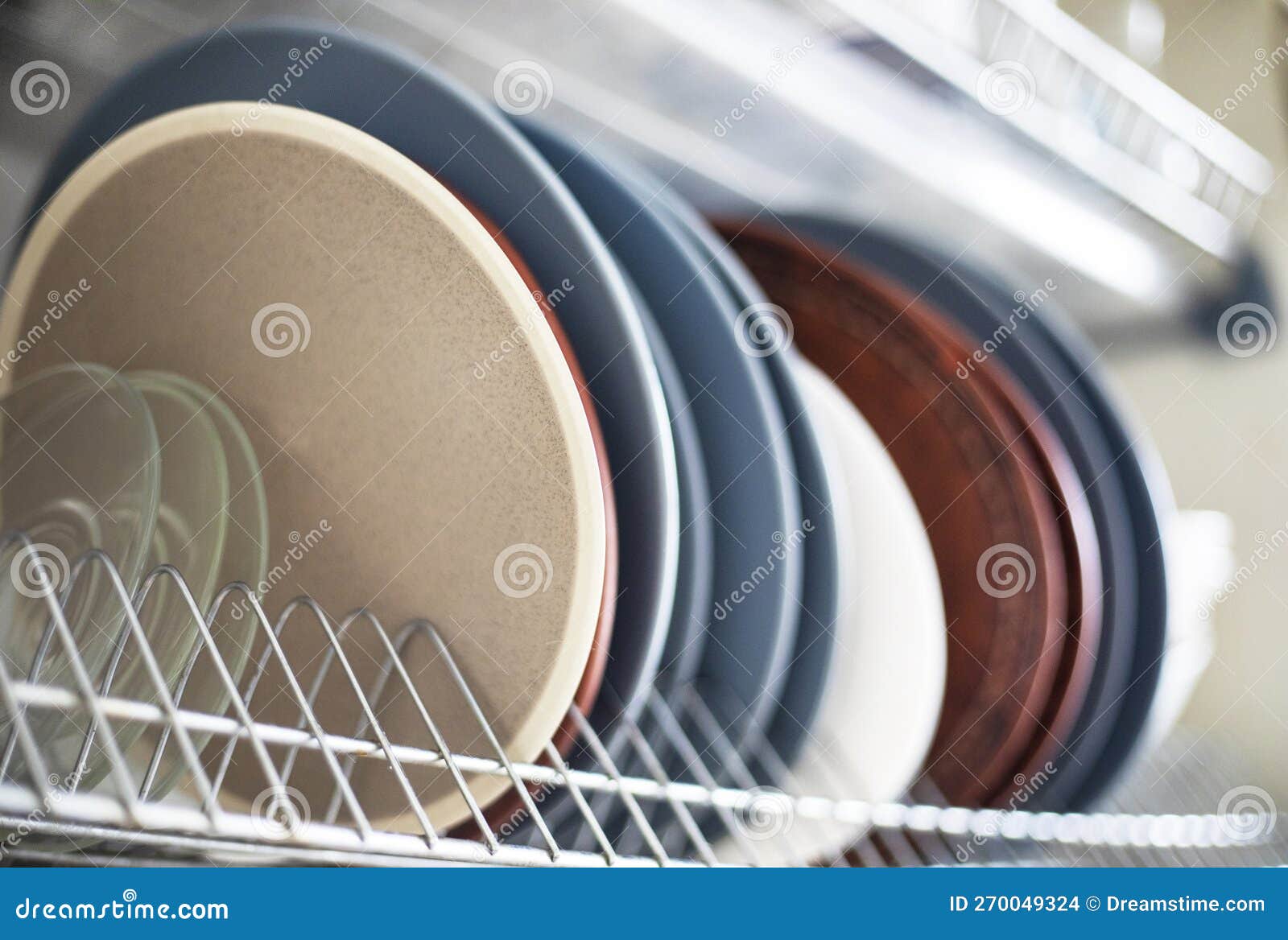 Ceramic and Glass Plates of Different Sizes on a Stand in the Kitchen ...