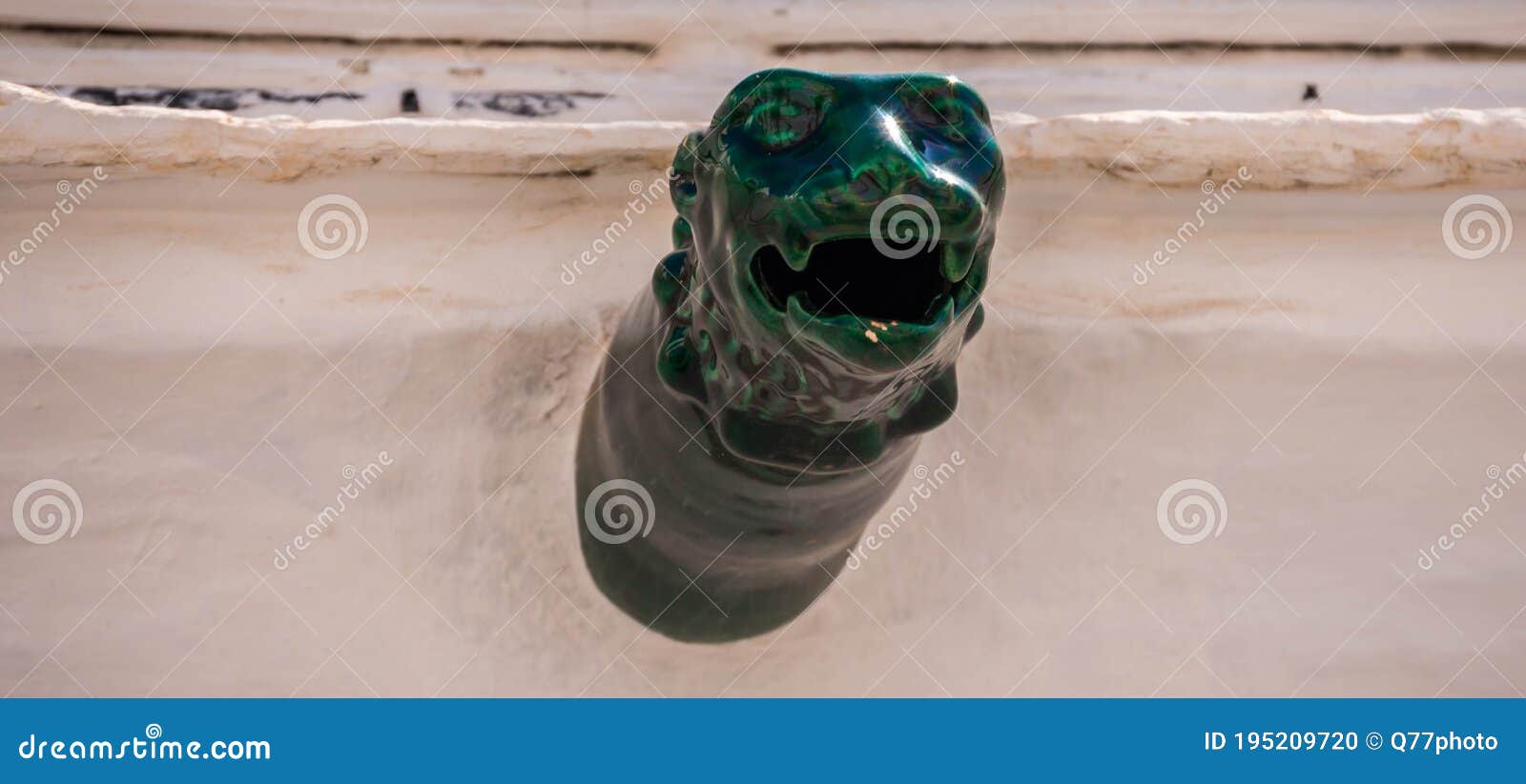 Ceramic Green Gargoyle on a White Wall, an Interesting Traditional ...