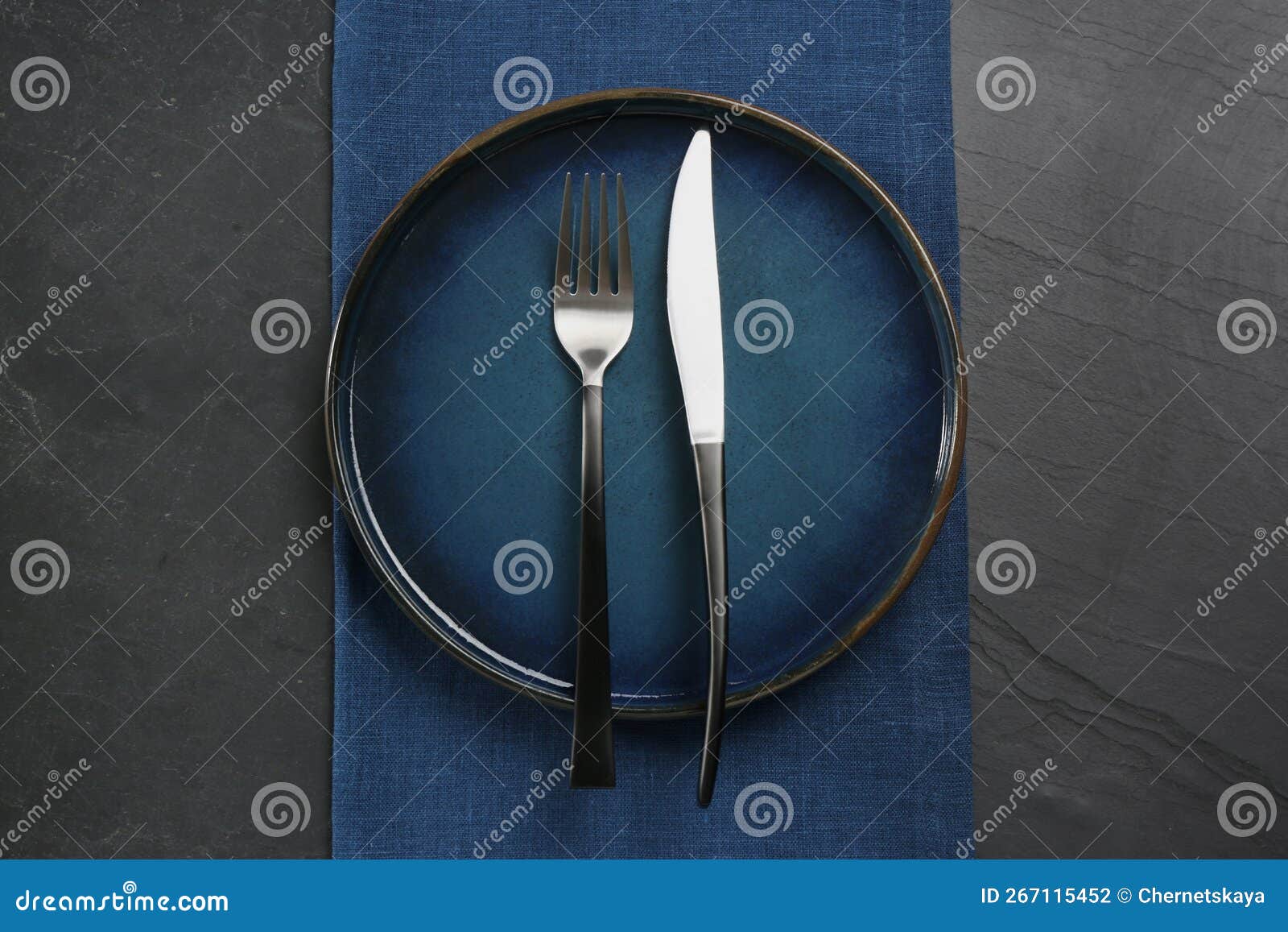 Ceramic Plate, Fork and Knife on Black Table, Top View Stock Photo ...