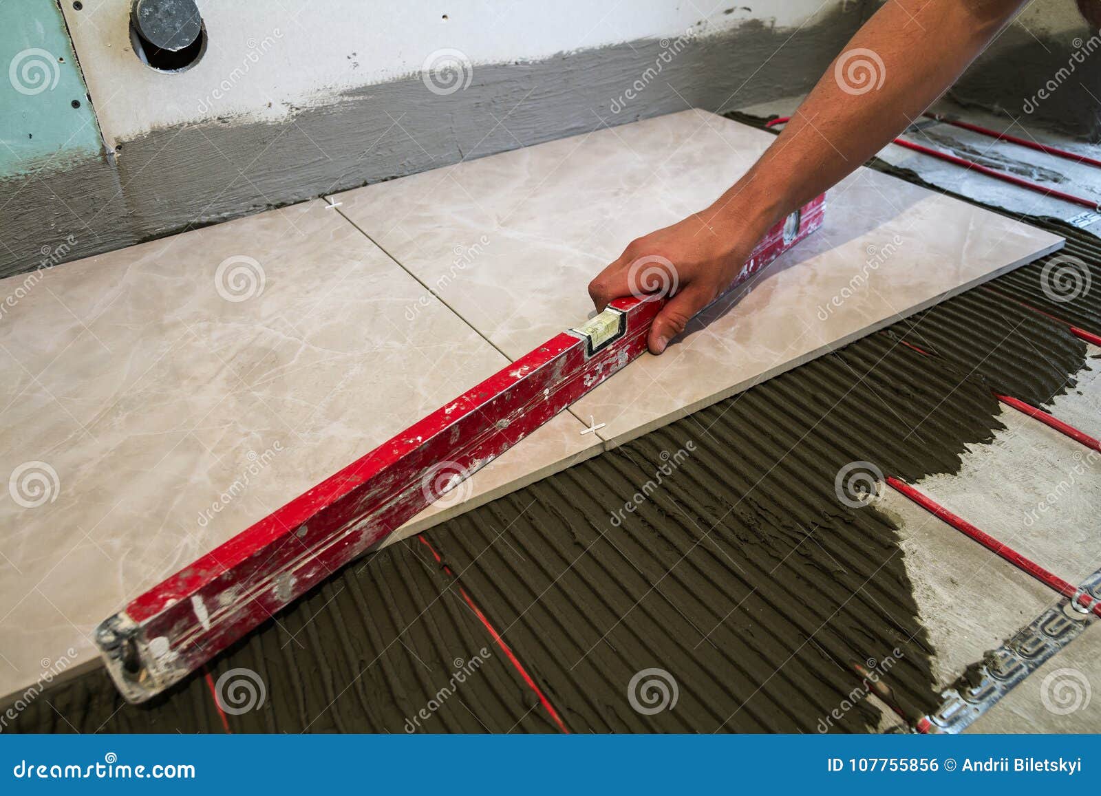 Ceramic Tiles and Tools for Tiler. Worker Hand Installing Floor Stock ...