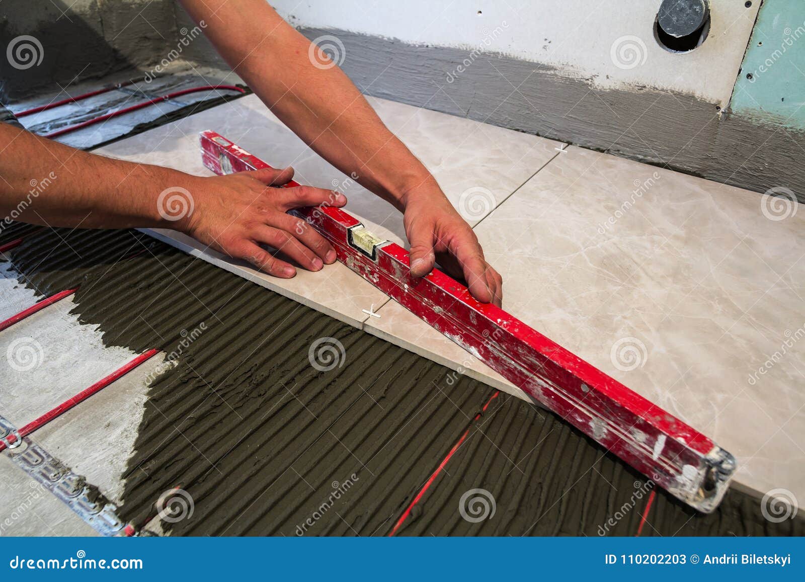 Ceramic Tiles and Tools for Tiler. Worker Hand Installing Floor Stock ...
