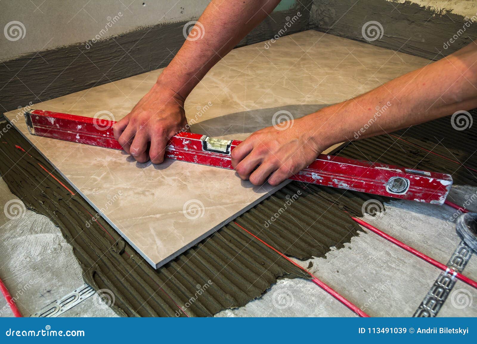 Ceramic Tiles and Tools for Tiler. Worker Hand Installing Floor Stock ...
