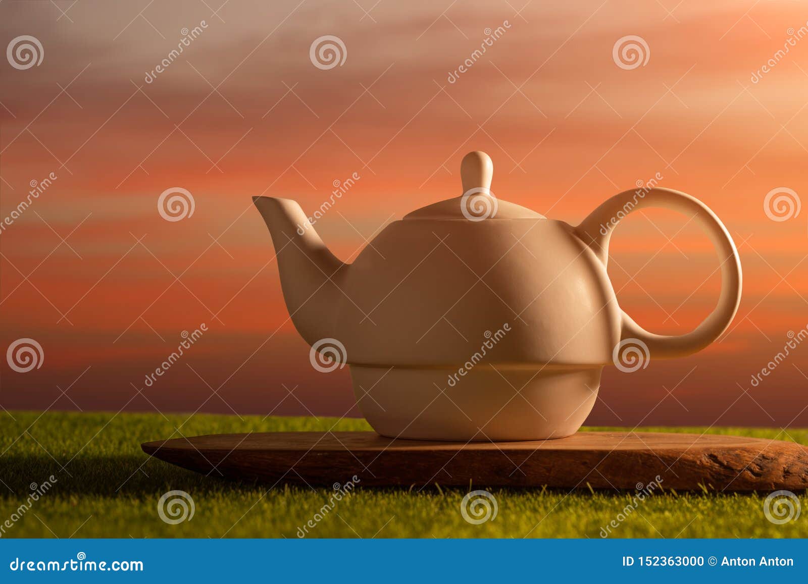 Ceramic White Teapot on Green Grass at Sunset Background Stock Photo ...