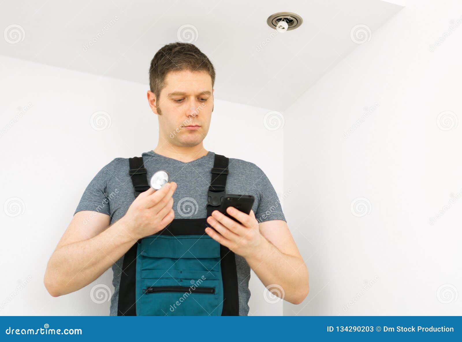 Man Checking Information about Light Bulb Stock Image - Image of ...