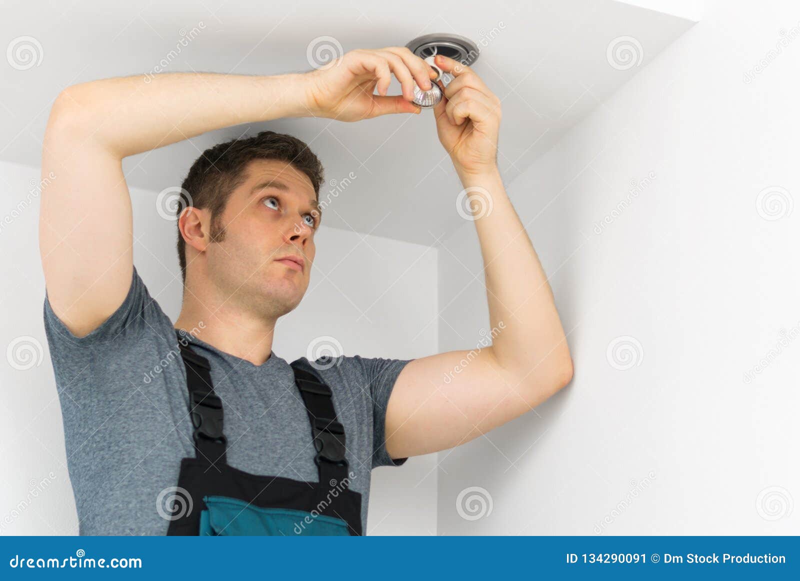 Man installing light bulb stock image. Image of mechanic - 134290091