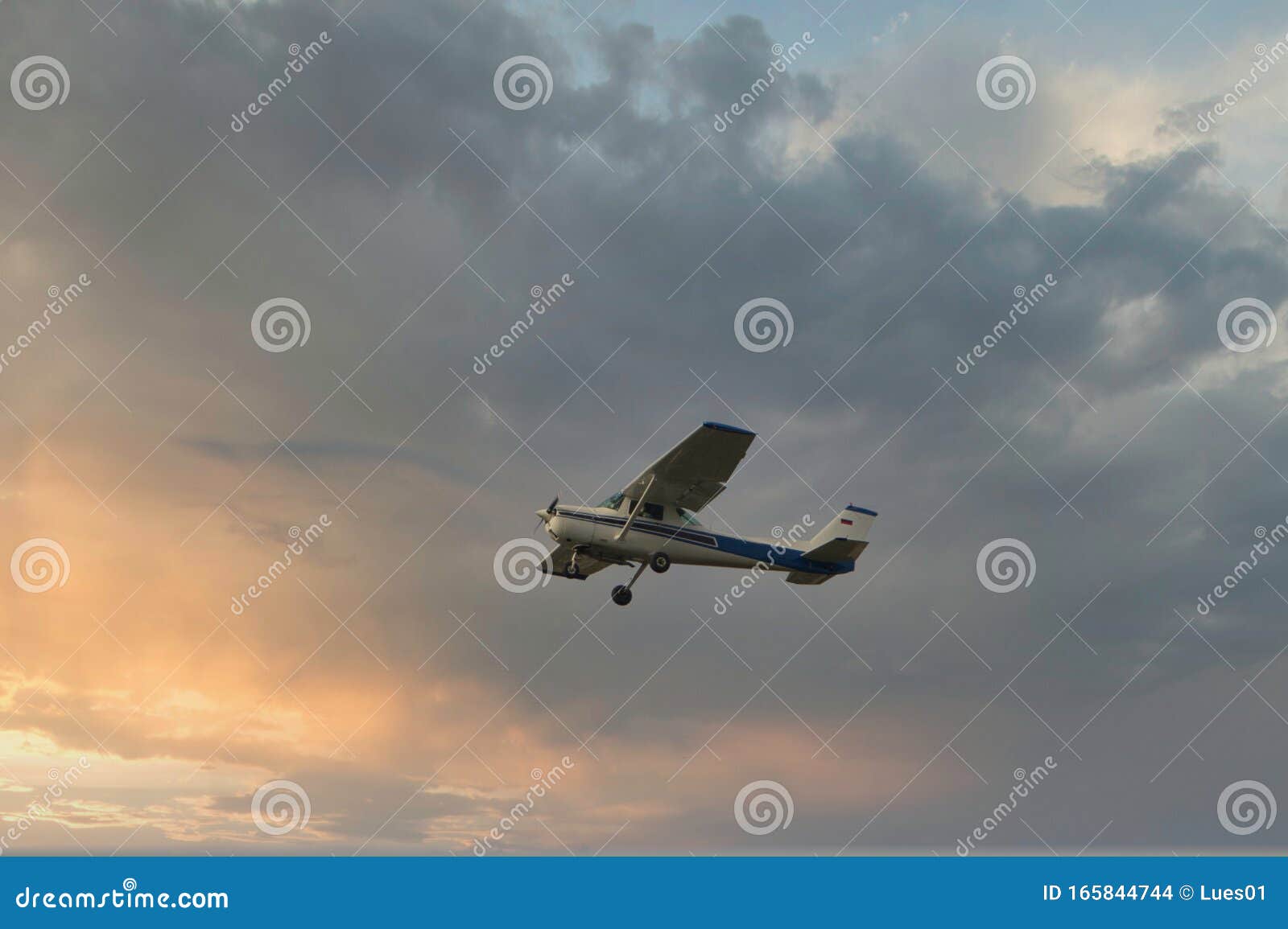 Cessna Plane Flying at Sunset in the Clouds Stock Photo - Image of ...