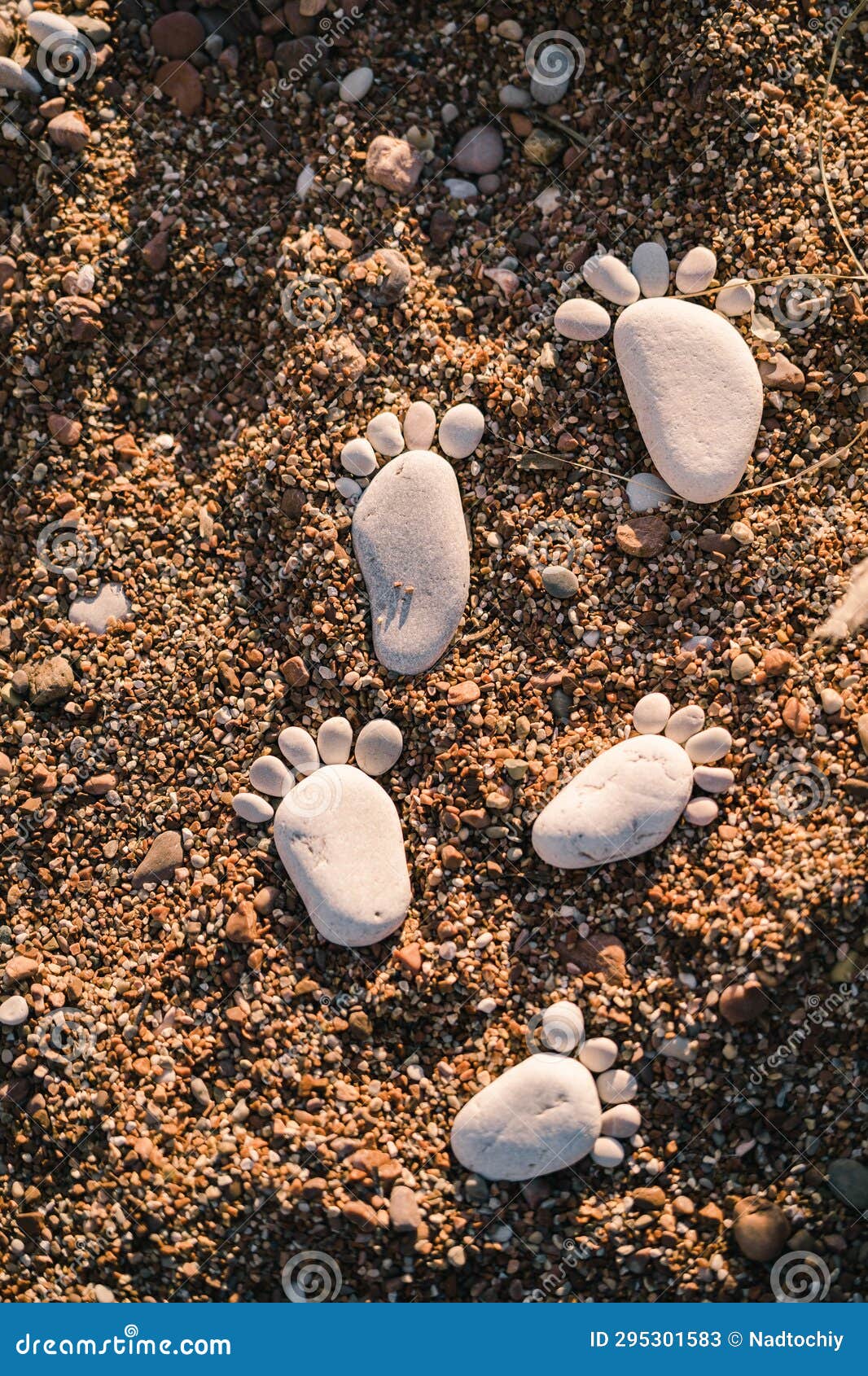 Chain of Footprints of Bare Feet Made of Pebbles in the Sand Stock ...