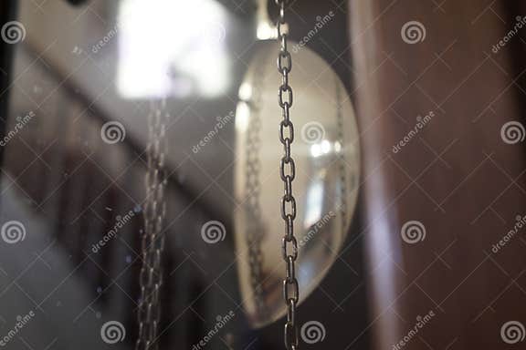A Chain Hangs from a Clock, and the Chain is Silver Stock Photo - Image ...
