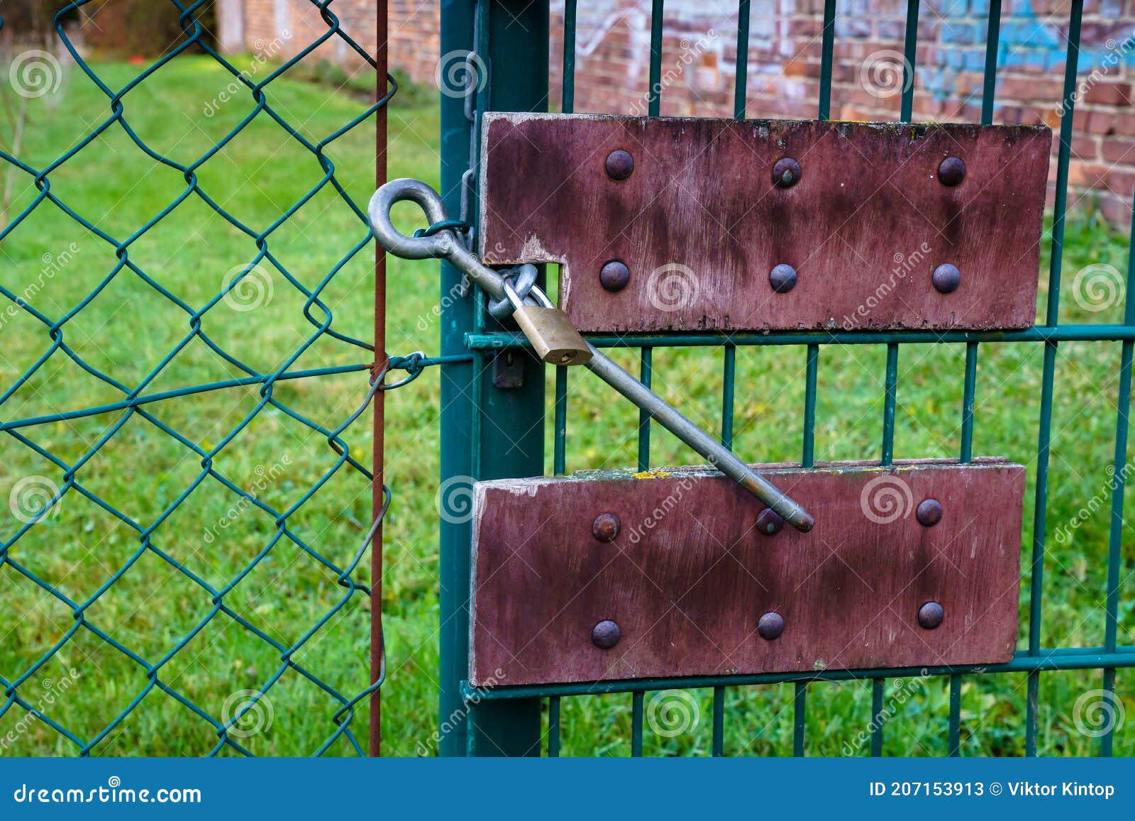 Chain Link Fence. Rusty Riveted Plates and Padlock Stock Image - Image ...