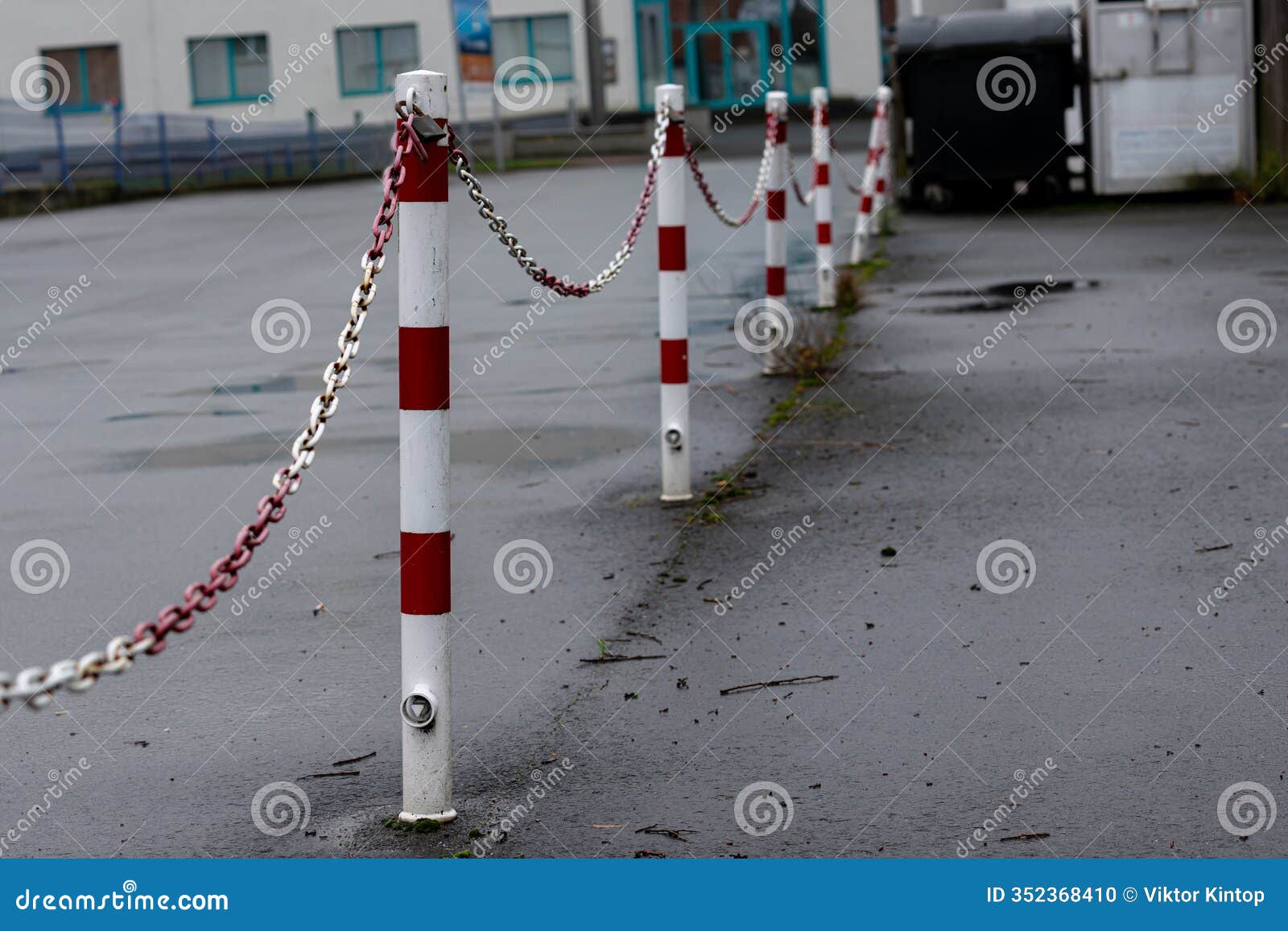 Chain-linked Posts Line a Wet Surface in an Empty Parking Area Stock ...