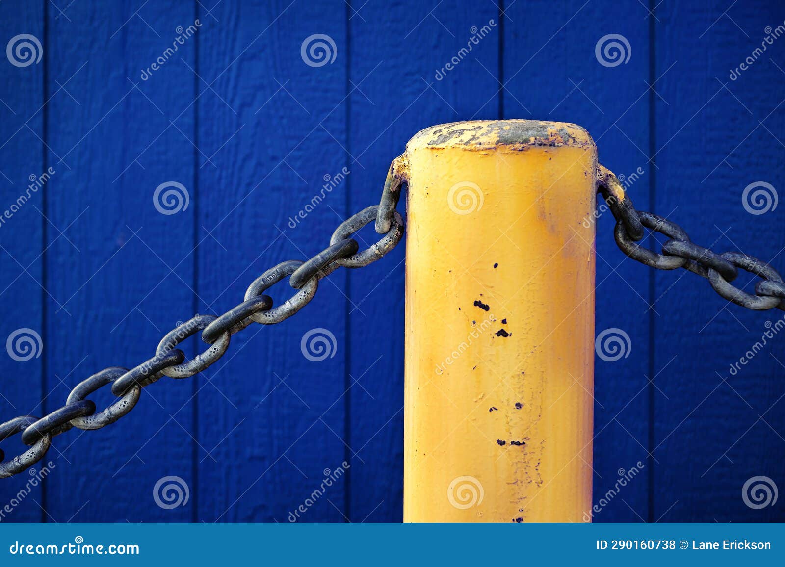 Chain and Yellow Pole for Security with Blue Wall Background Safety ...