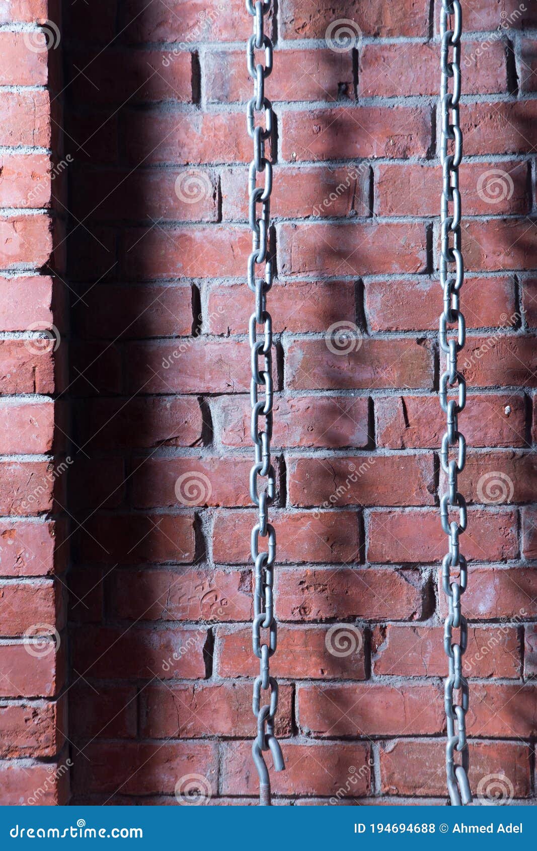 Chains on a brick wall stock photo. Image of chain, chandelier - 194694688