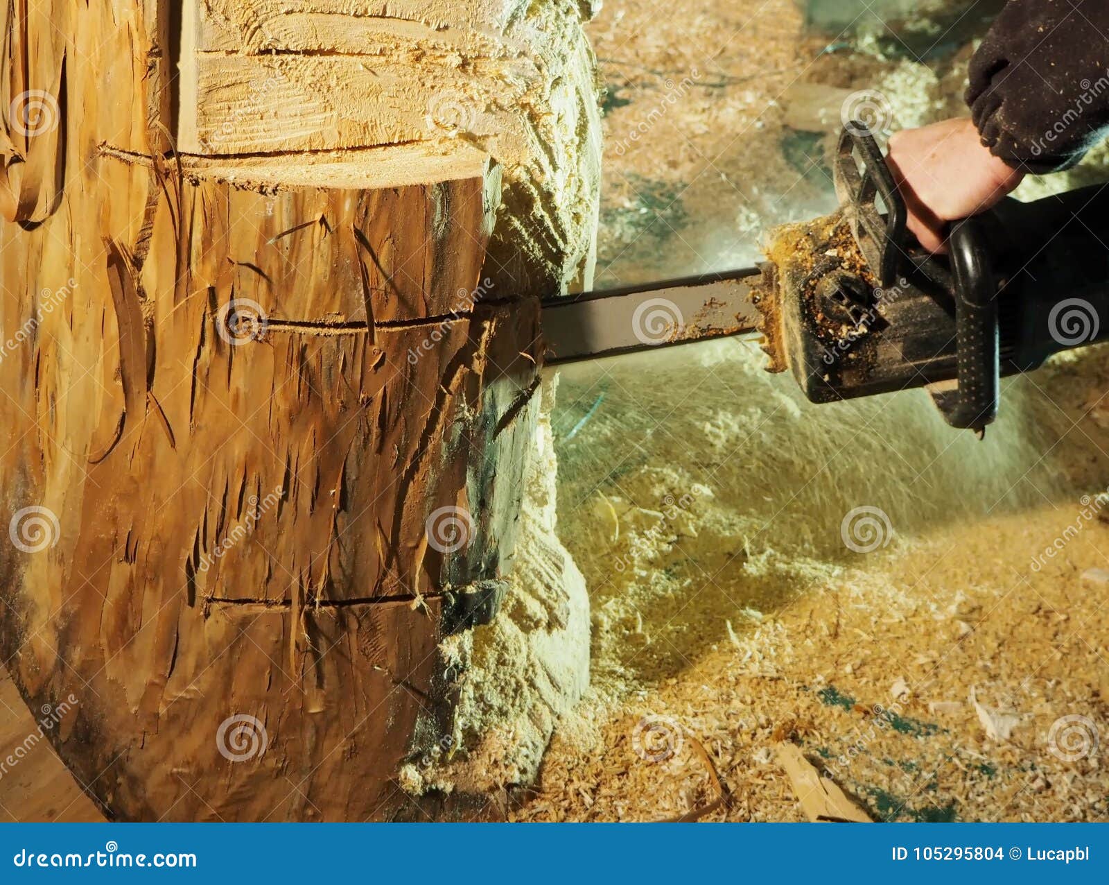 Chainsaw Cuts a Tree Trunk Under Electric Lights Stock Photo - Image of ...