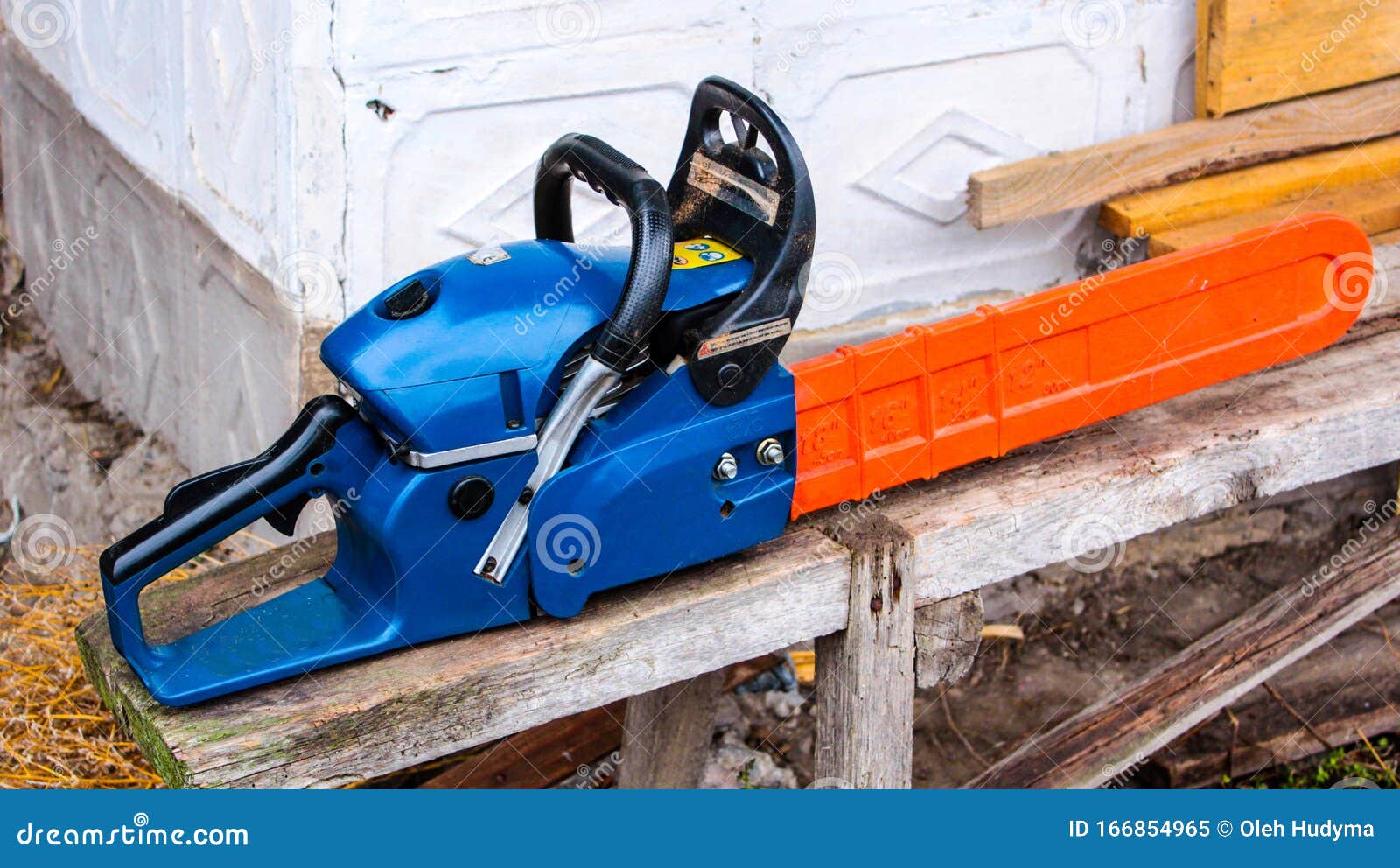 A Chainsaw is Standing on a Bench a Chainsaw with a Tire and a Casing ...