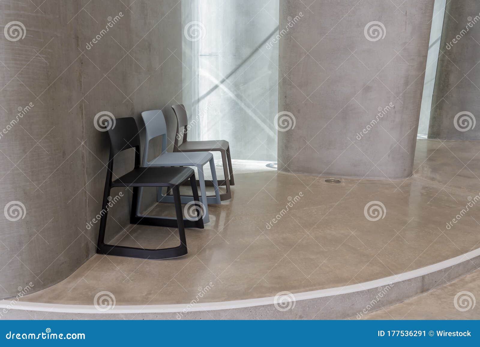 Chairs Against a Wall in a Modern Concrete Building Stock Image - Image ...