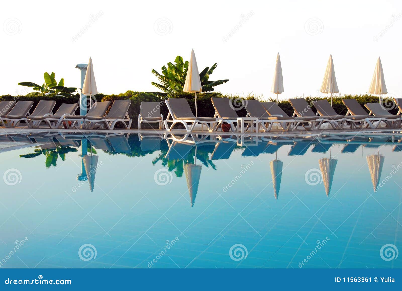 Chairs by swimming pool stock image. Image of chairs - 11563361