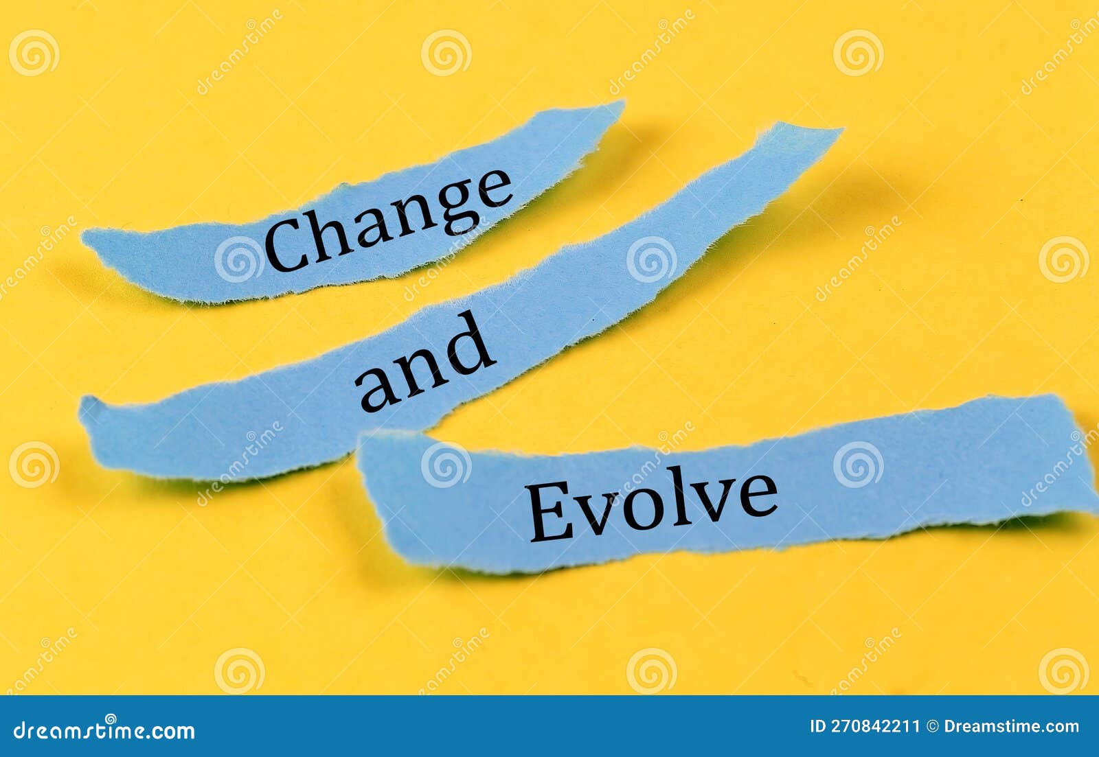 CHANGE and EVOLVE Text on a Blue Pieces of Paper on Yellow Background ...