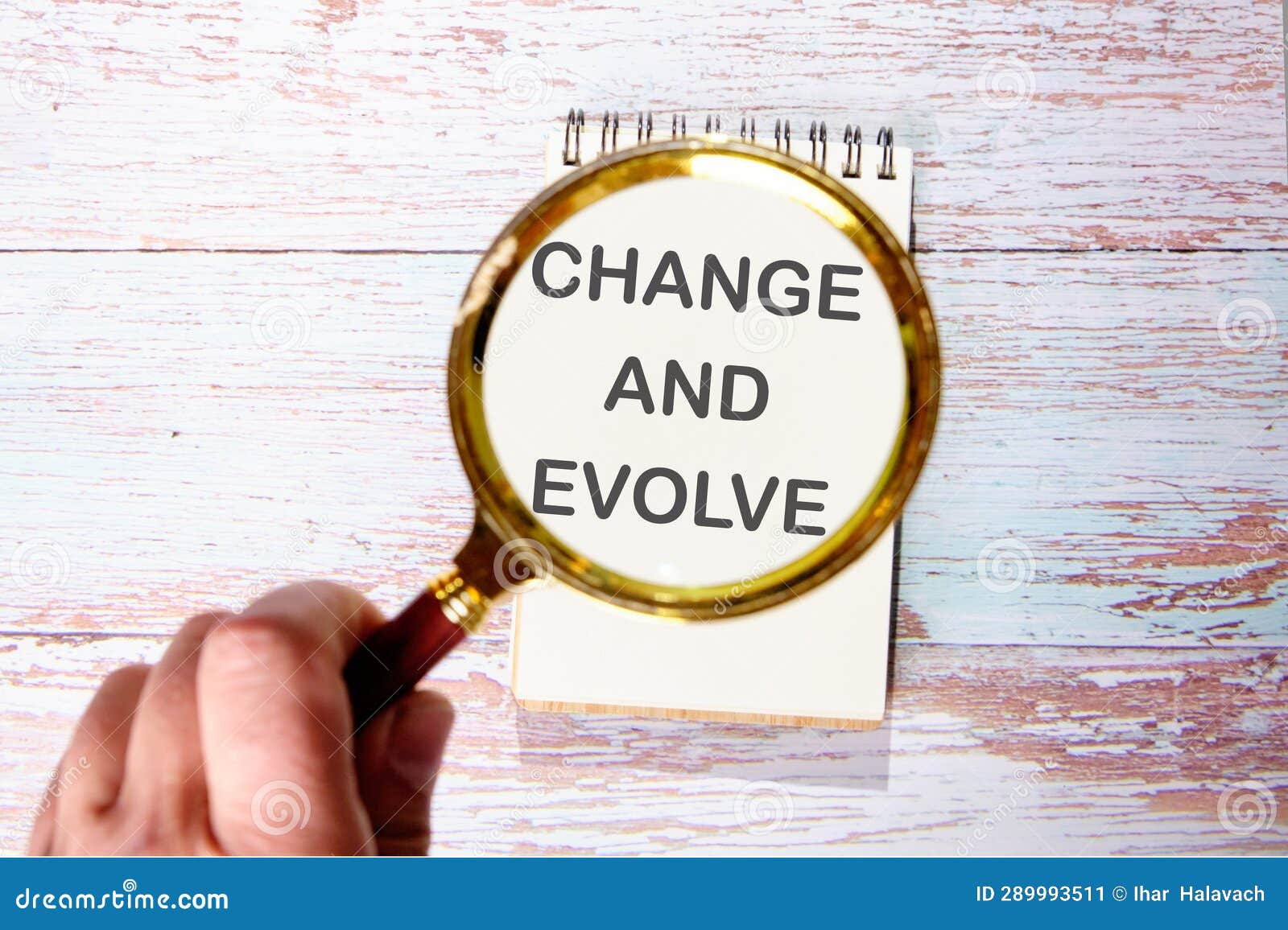 CHANGE and EVOLVE Text Seen through Magnifying Glasses on a Notepad ...