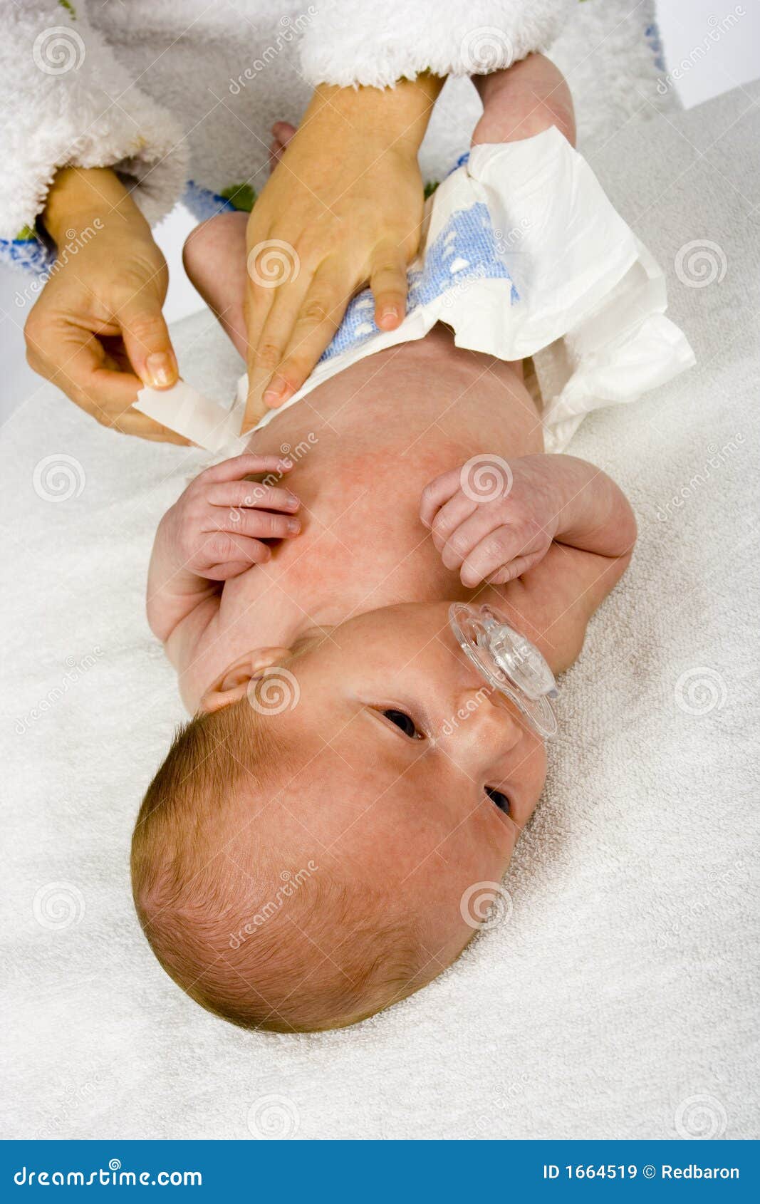 Changing the baby s nappy stock image. Image of gentle - 1664519