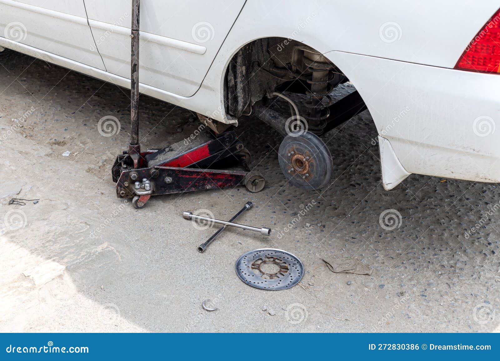 Changing Car Rear Wheel Lifted by Hydraulic Jack Stock Photo - Image of ...