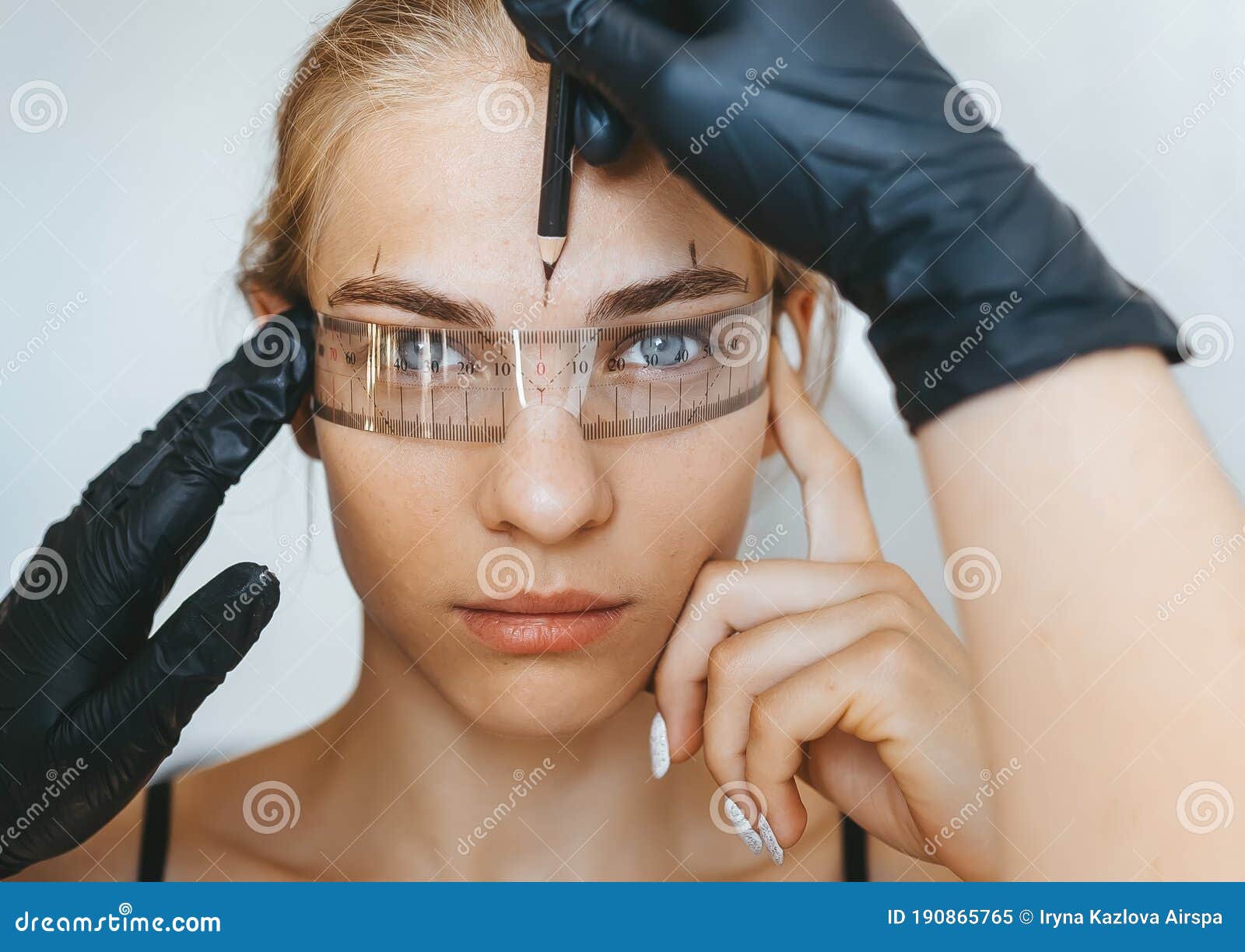 Changing the Shape of the Brows. Stylist Measuring the Eyebrows with ...