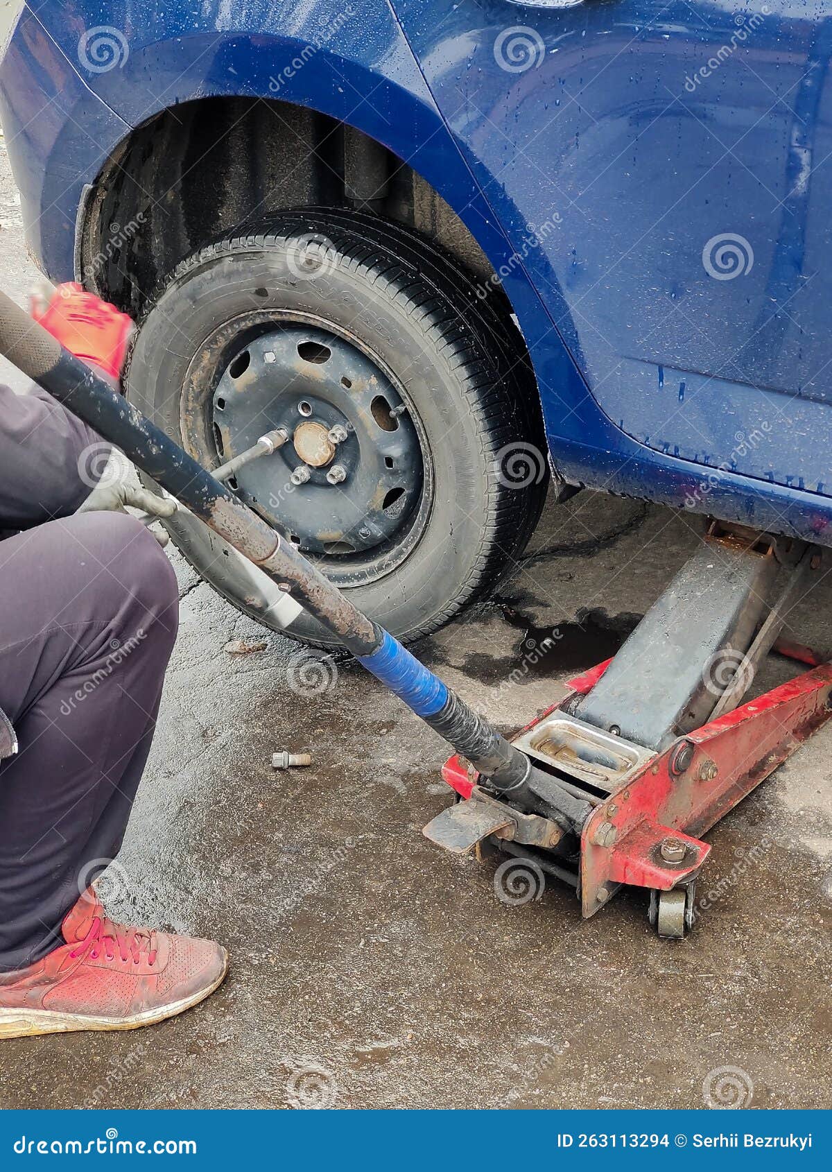 Changing a Wheel on a Car Jack at a Car Service Station Stock Photo ...