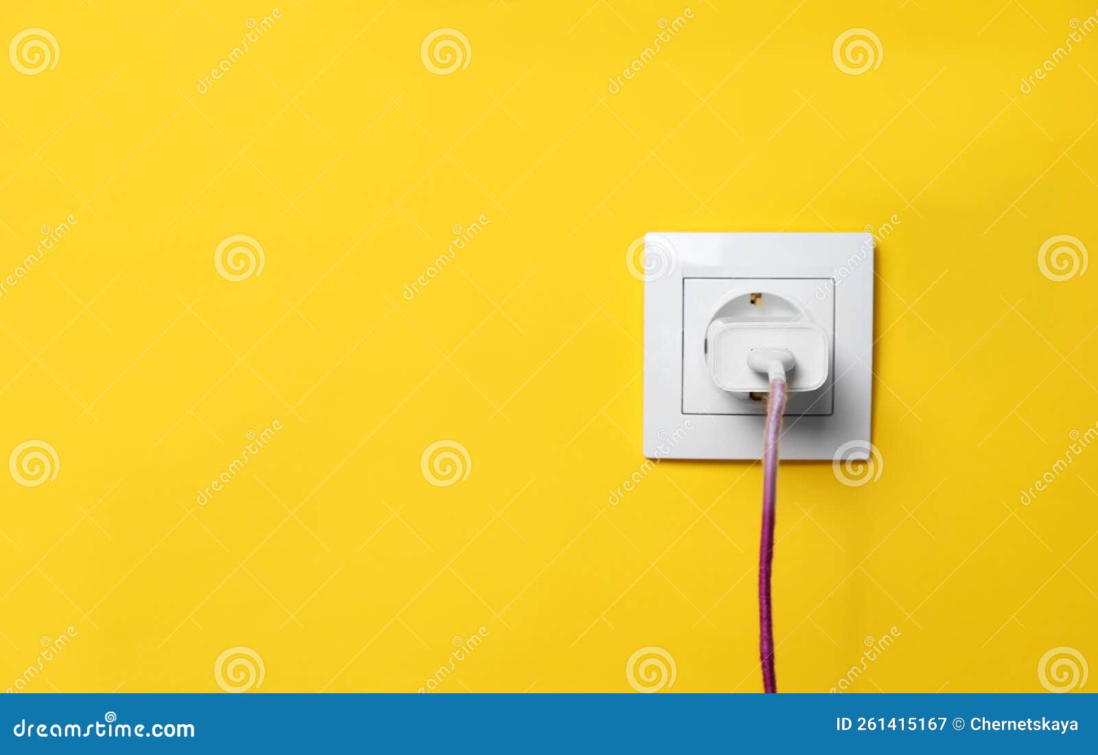 Charger Adapter Plugged into Power Socket on Yellow Wall, Space for ...