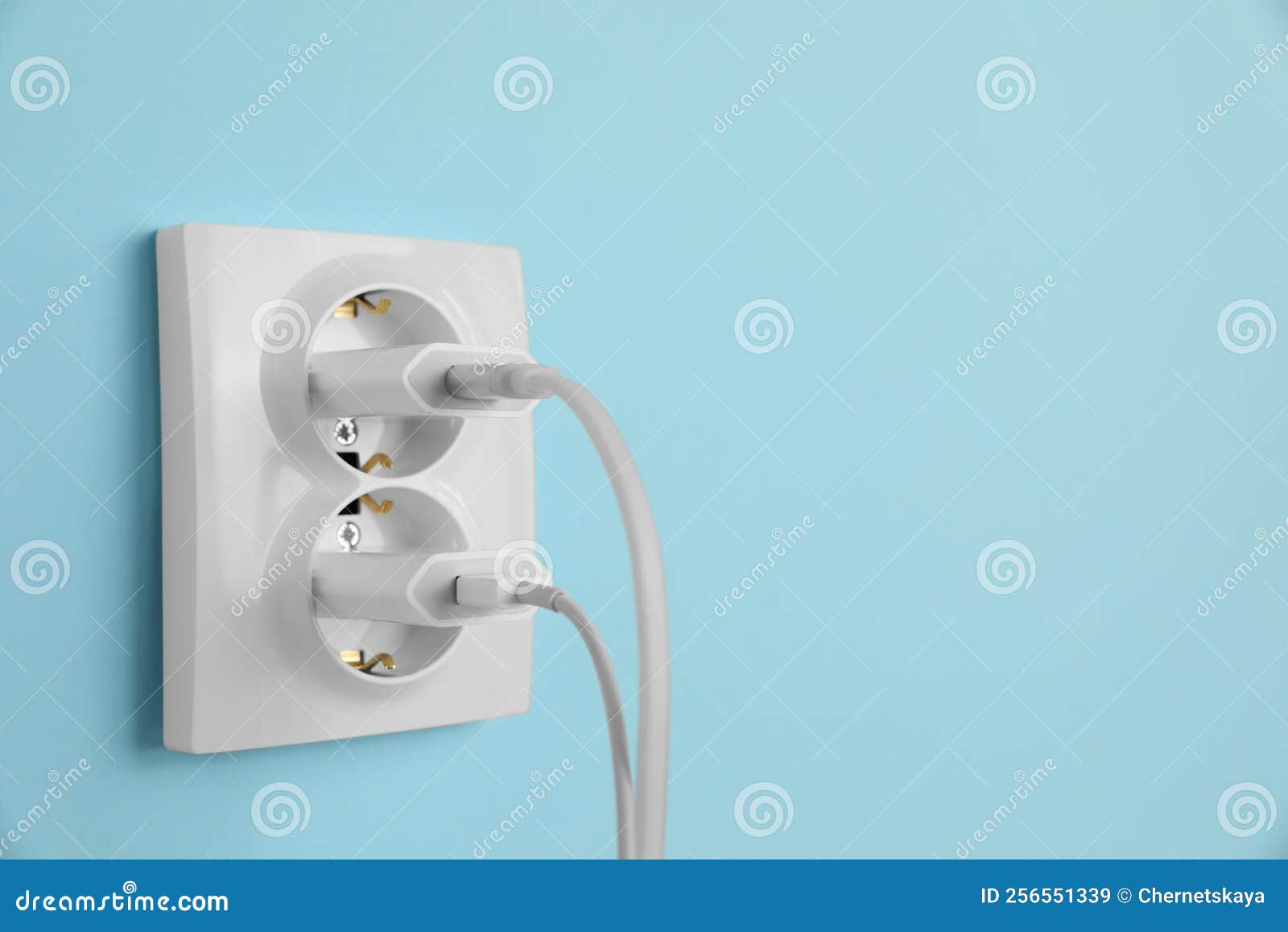 Charger Adapters Plugged into Power Sockets on Light Blue Wall, Space ...