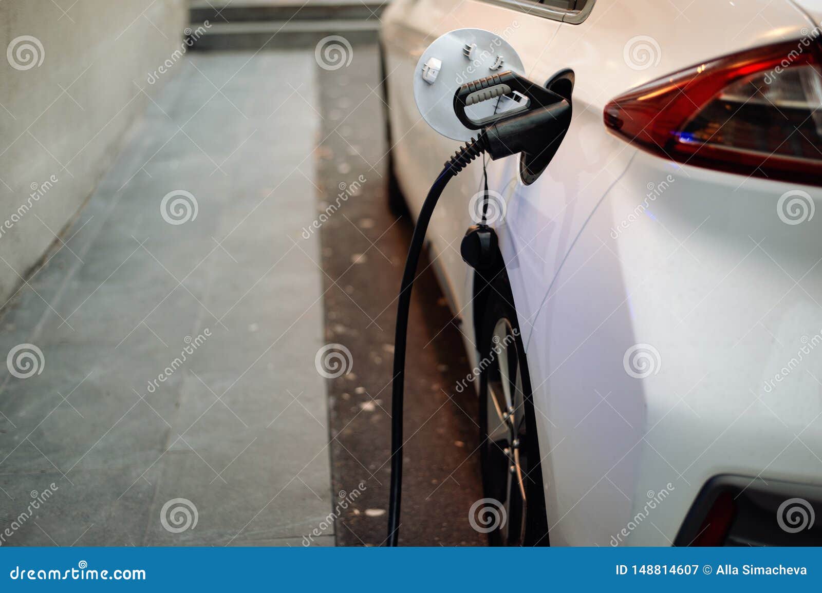 Charging an Electric Car with the Power Cable Supply Plugged in. Stock ...