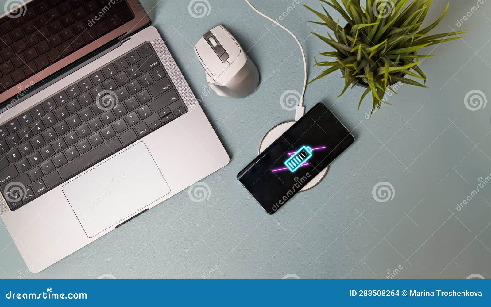 Charging Mobile Phone Battery with Wireless Charging Device on the ...