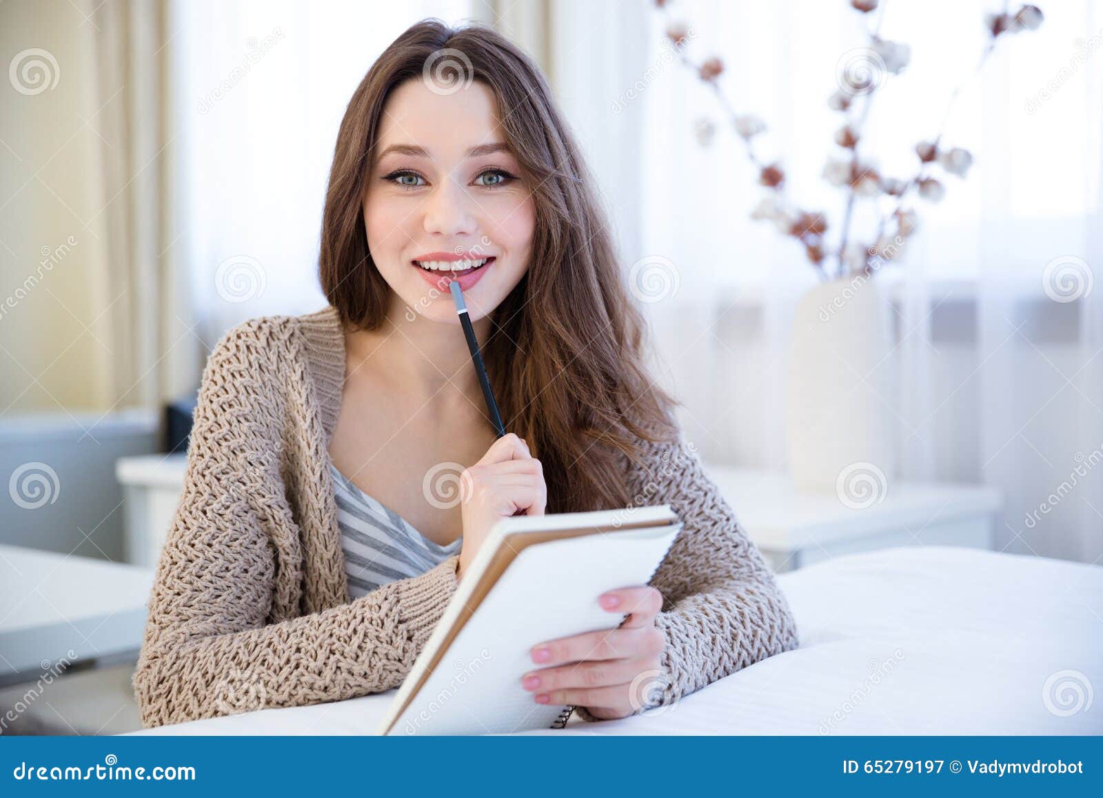 Charming Cheerful Young Woman Thinking and Writing in Notepad Stock ...