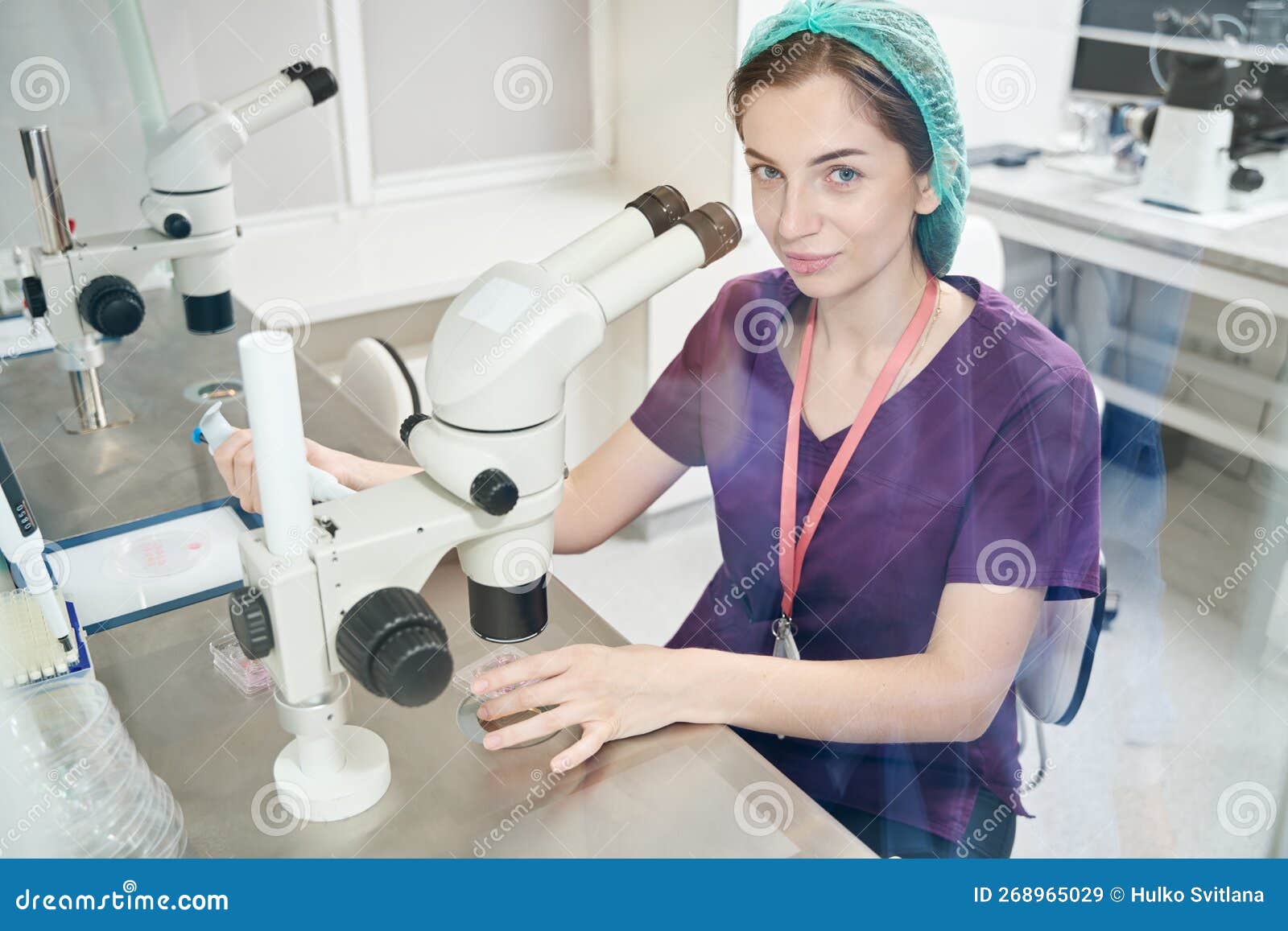 Charming Female Laboratory Assistant Sits at the Workplace in ...