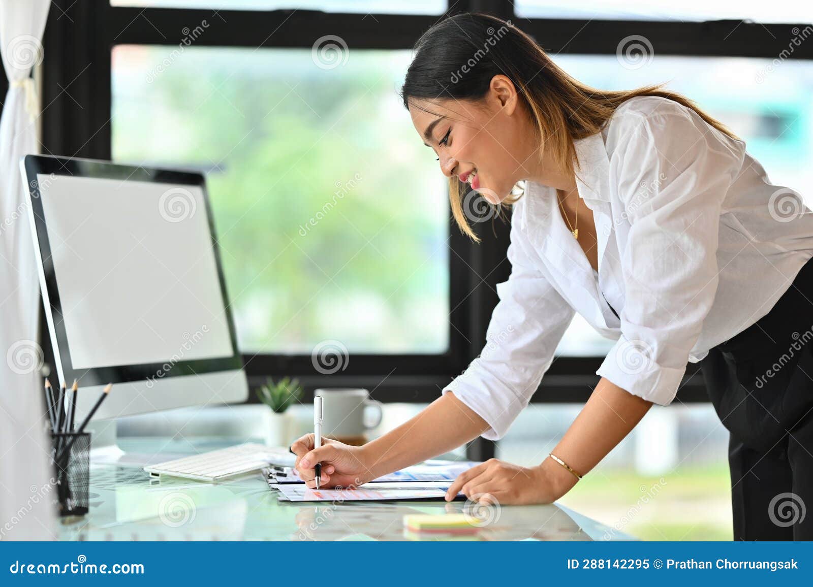 Charming Millennial Female Manager Standing at Her Workplace and ...