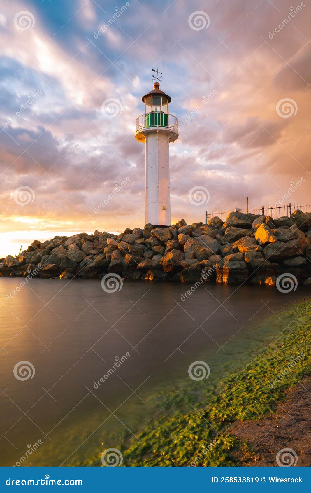 Charming Sunset Scene with a View of Old Lighthouse Stock Image - Image ...